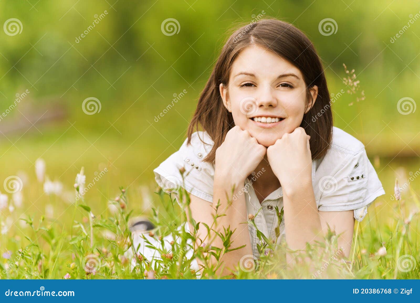 Teen girl lying on grass stock photo. Image of cute, brunette - 20386768