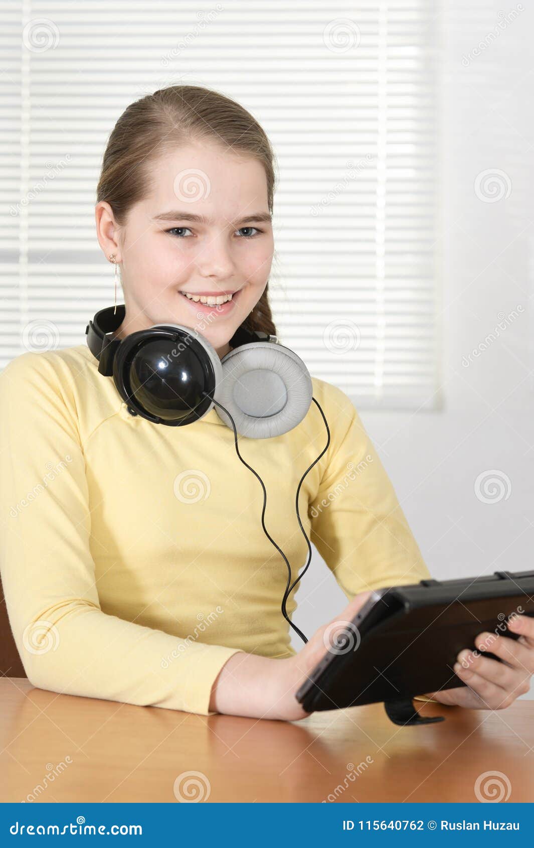 Teen girl using tablet stock photo. Image of headphones - 115640762
