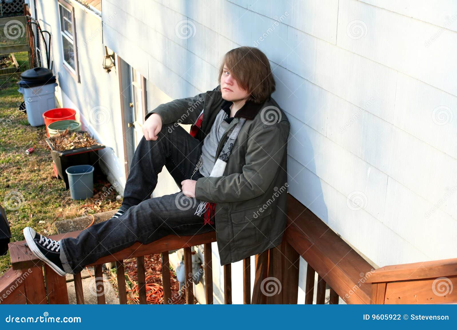 Teen Sitting on Railing stock photo. Image of looking - 9605922