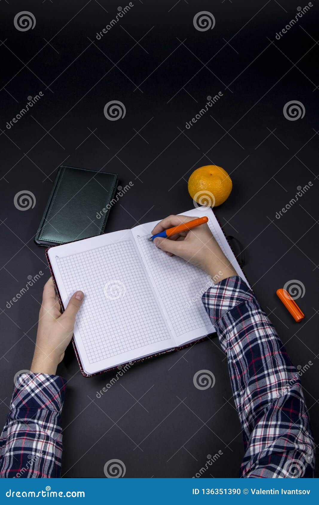 Teen Writes with a Pen in an Open Notebook on the Table Stock Photo ...