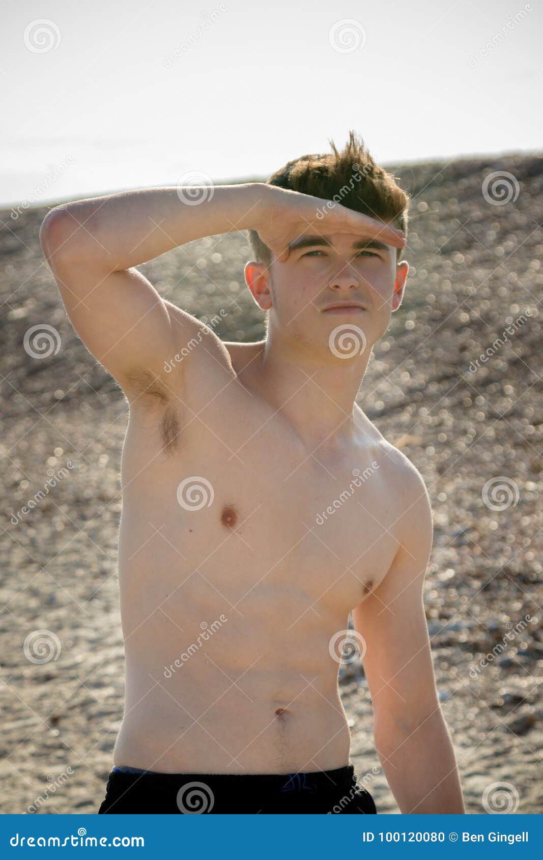 Teenage boy at the beach stock photo. Image of male - 100120080