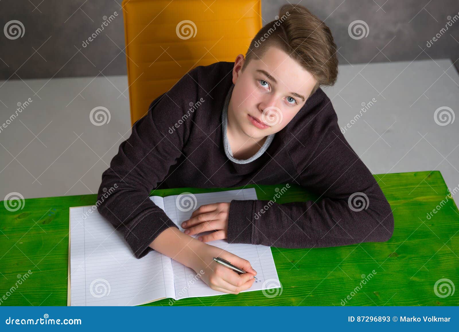 Teenage boy doing homework stock image. Image of concentration - 87296893