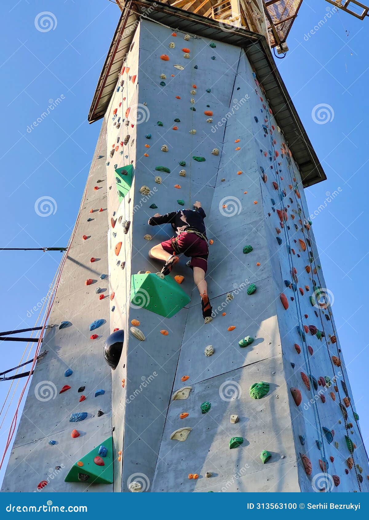 A Teenage Boy is Doing Training and Climbing a Climbing Wall on a ...