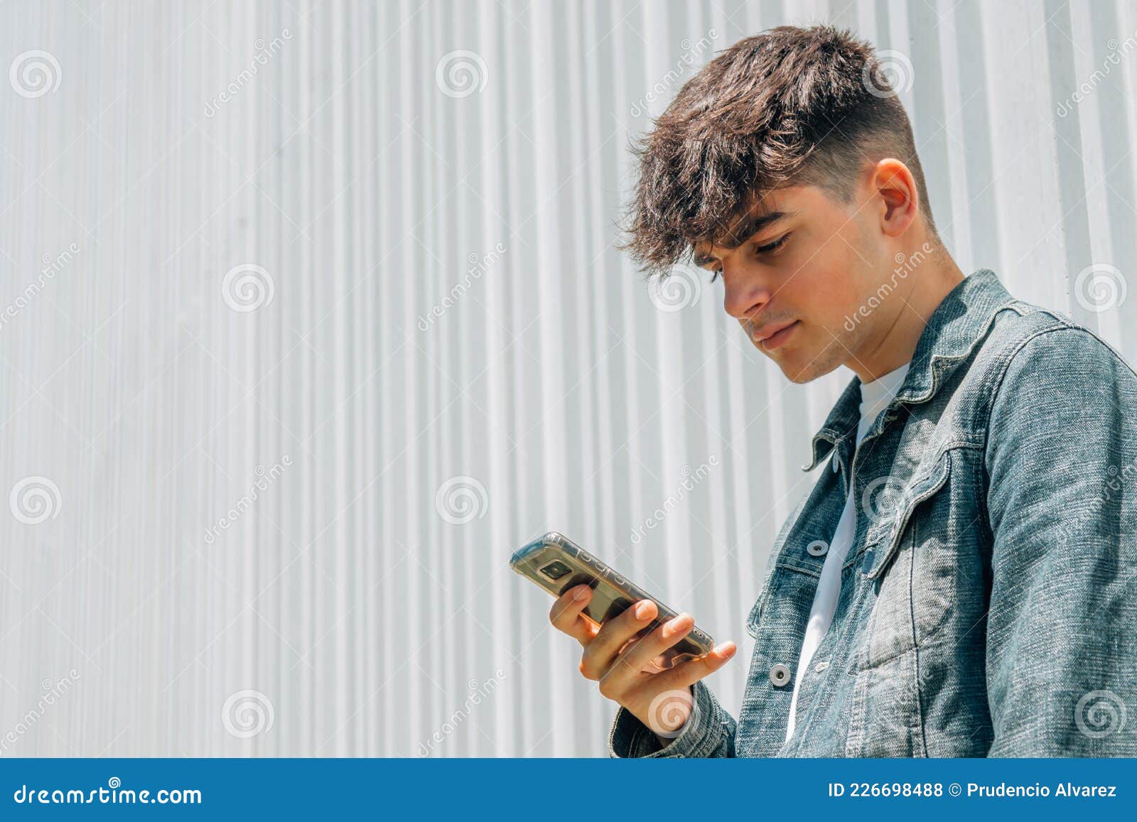 Boy Looking at Mobile Phone Stock Photo - Image of communications ...