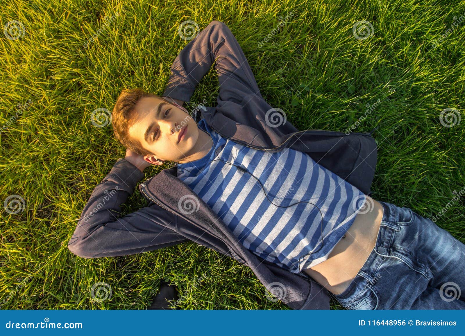 Teenage Boy Lying on Grass with Phone Stock Photo - Image of nature ... Teenage Boy Lying on Grass with Phone Stock Photo - Image of nature ...