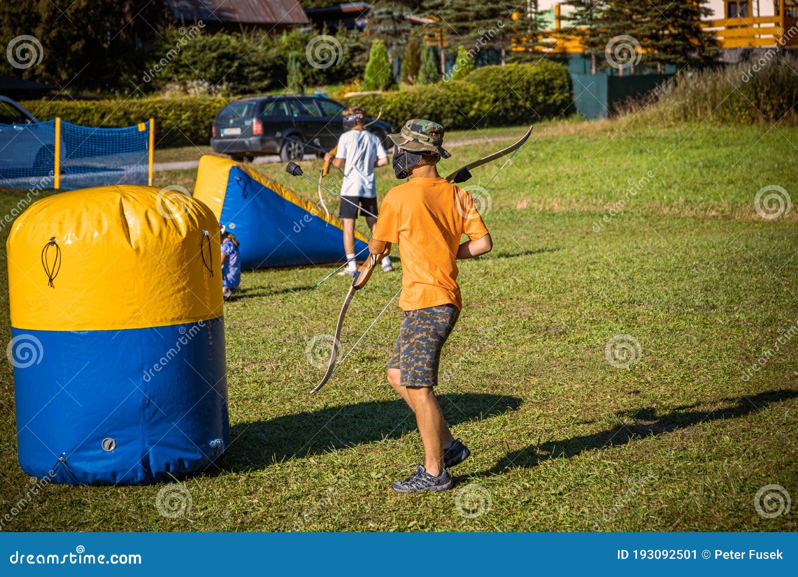 Teenage Boy Playing Archery Tag on a Meadow Stock Image - Image of ...
