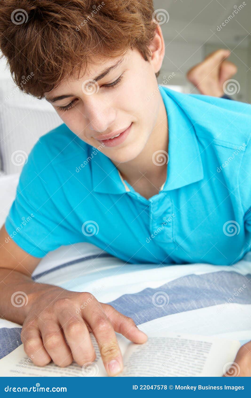 Teenage boy reading a book stock photo. Image of teenage - 22047578