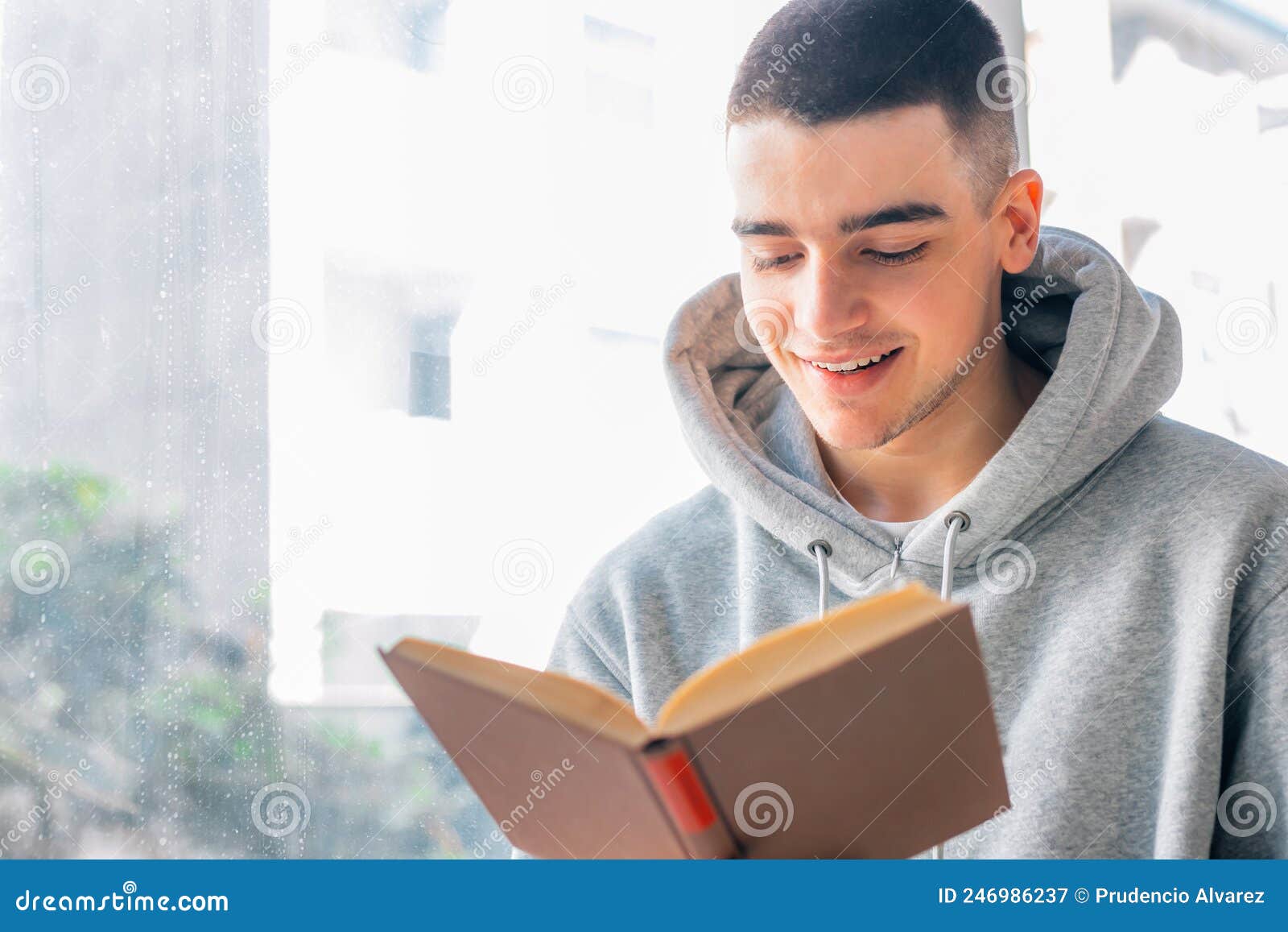 Boy reading a textbook stock image. Image of person - 246986237