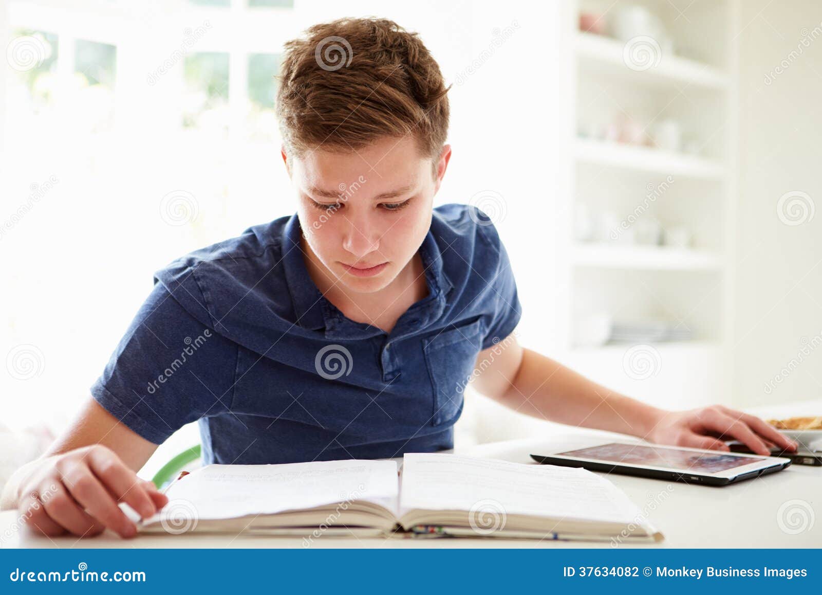 Teenage Boy Studying Using Digital Tablet at Home Stock Photo - Image ...