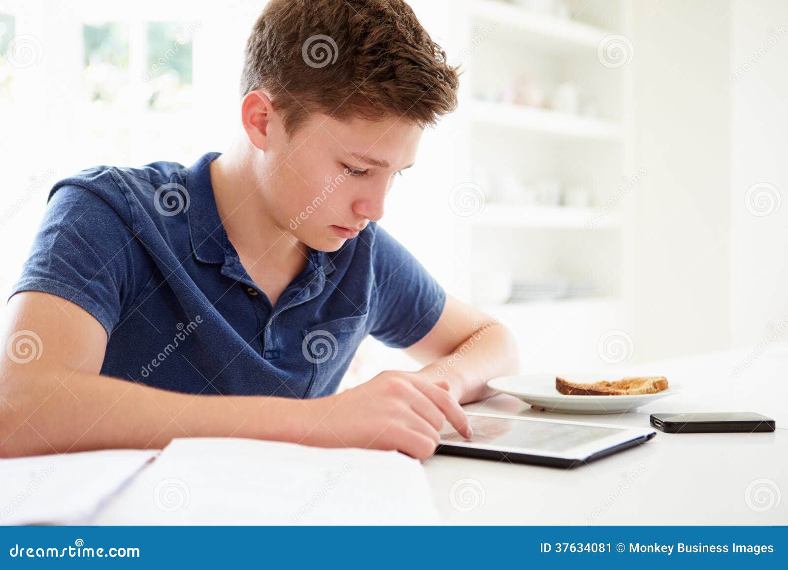 Teenage Boy Studying Using Digital Tablet at Home Stock Image - Image ...