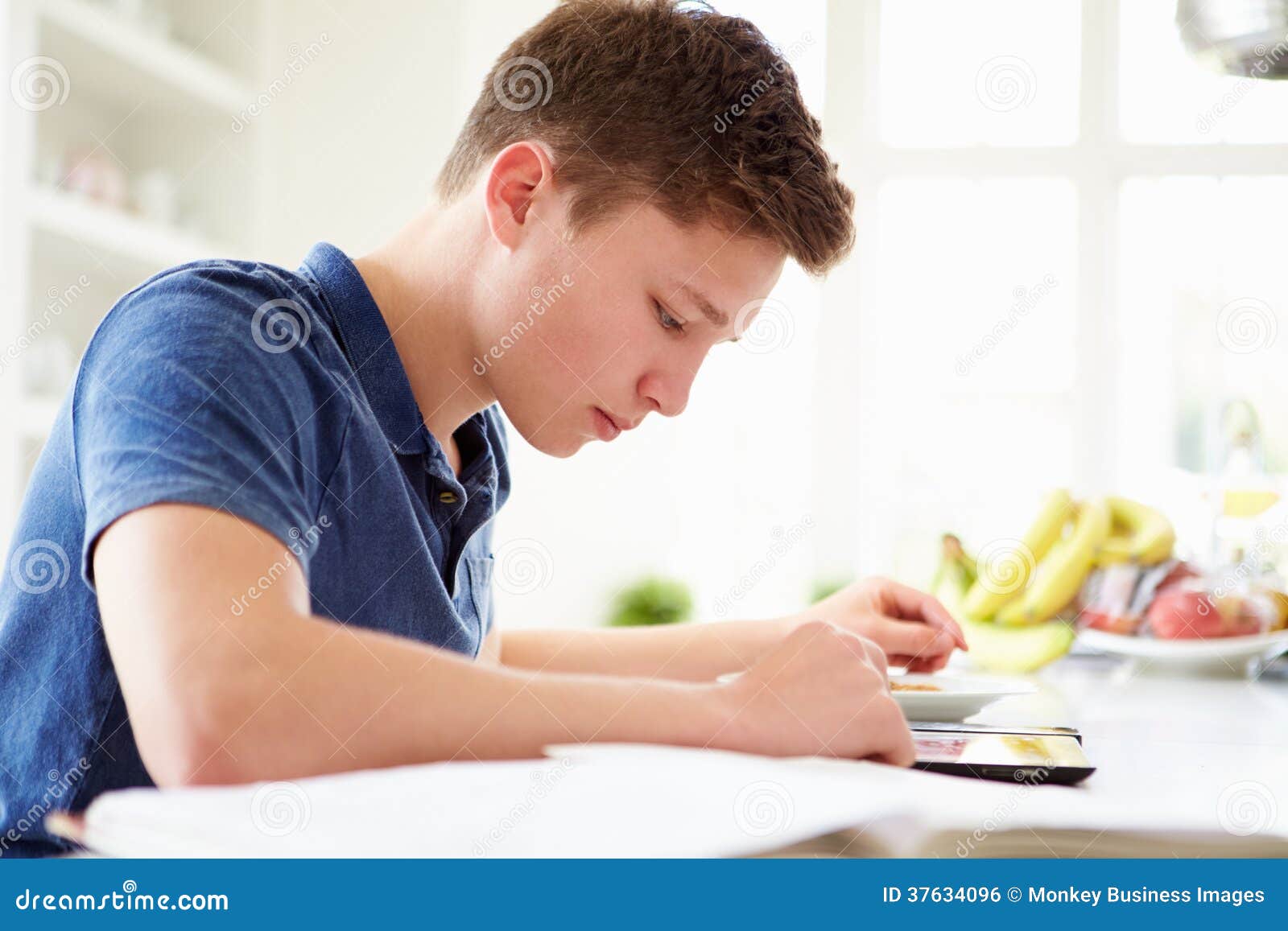 Teenage Boy Studying Using Digital Tablet at Home Stock Photo - Image ...