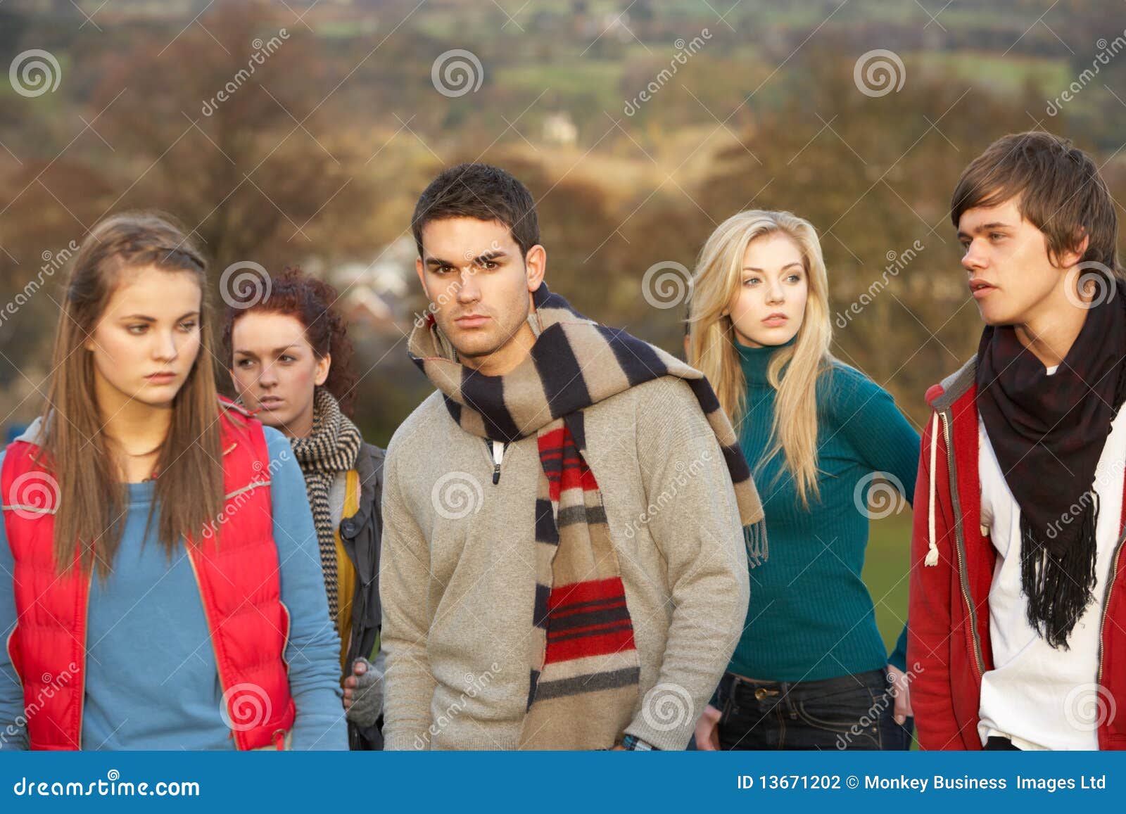 Teenage Boy Surrounded by Friends Stock Photo - Image of female, fall ...