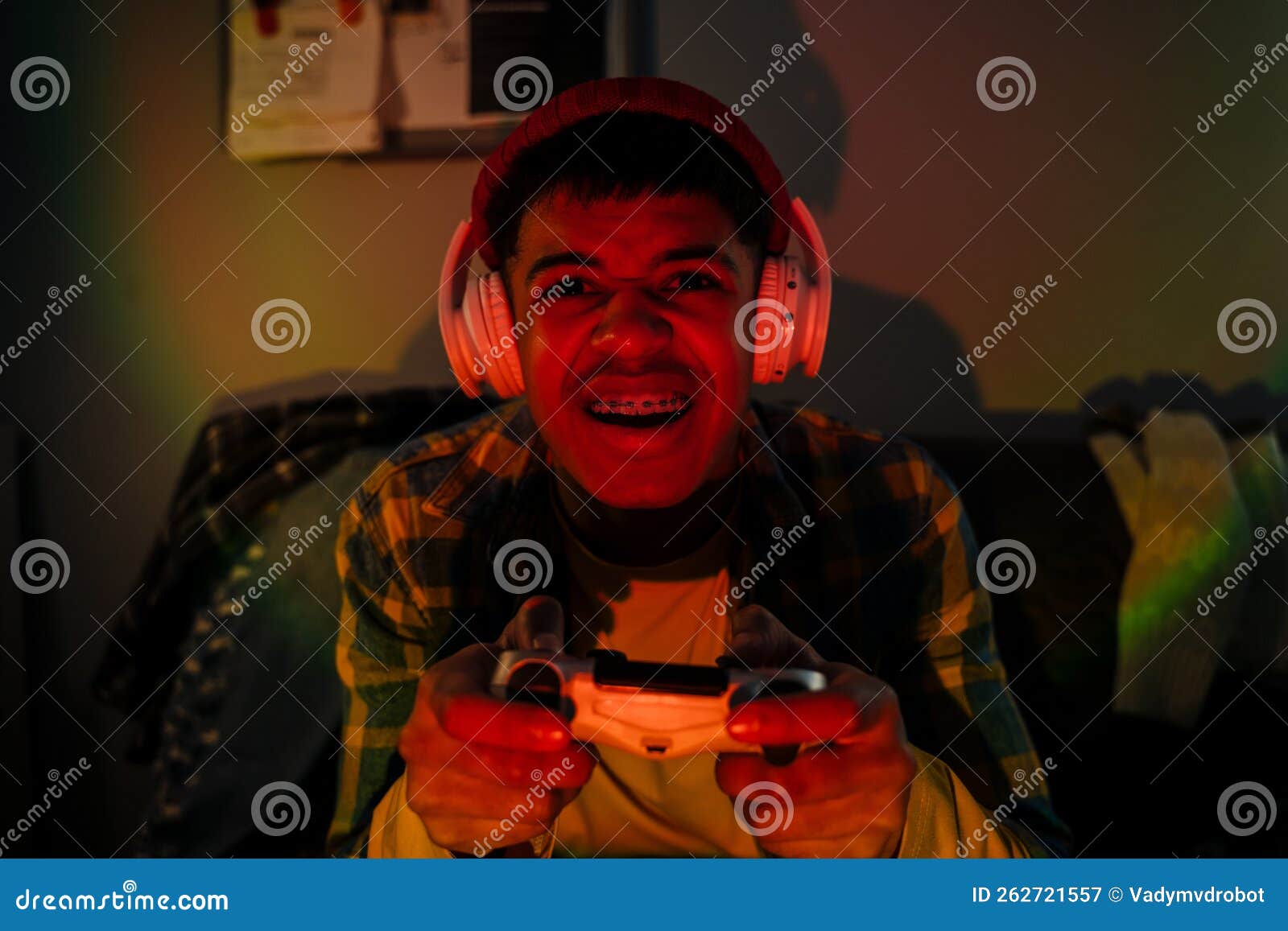Teenage Boy Using Headphones and Controller Playing Video Game at Home ...