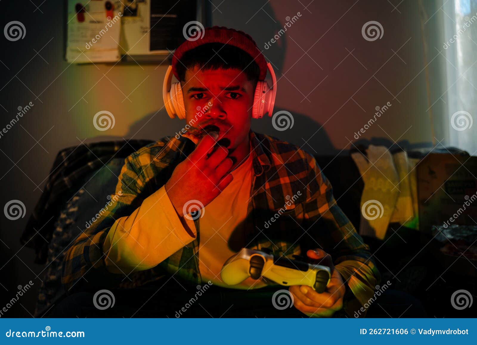 Teenage Boy Using Headphones and Controller Playing Video Game at Home ...