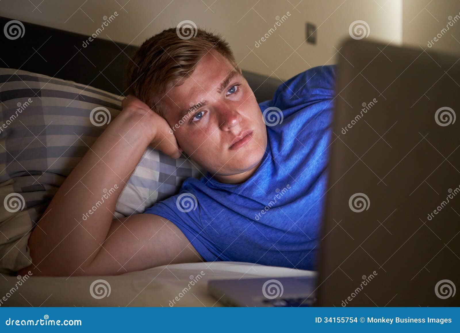 Teenage Boy Using Laptop in Bed at Night Stock Photo - Image of ...