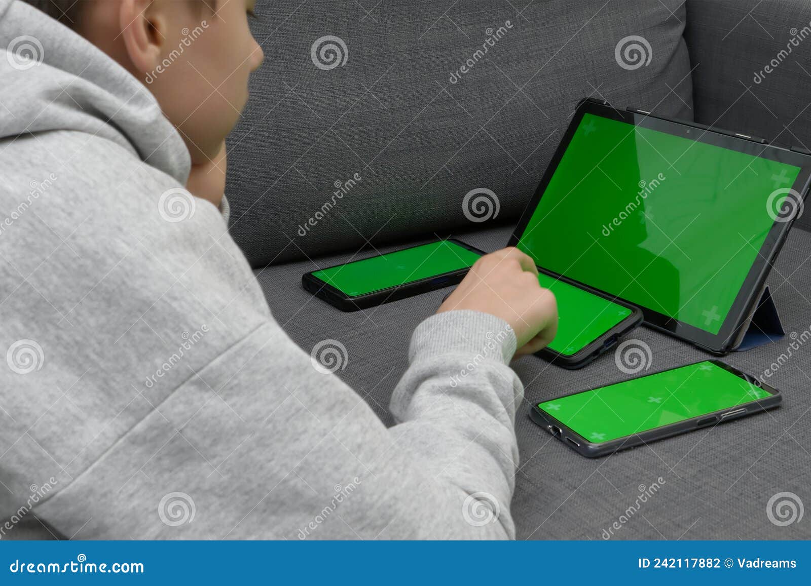 Teenage Boy Using Multiple Electronic Internet Devices in Same Time ...