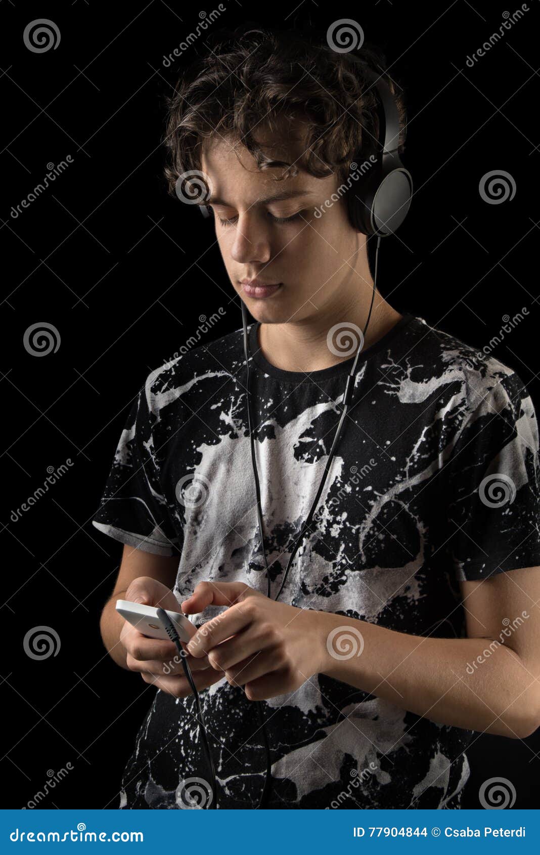 Teenage Boy Using Phone with Headset, Isolated on Black Stock Photo ...