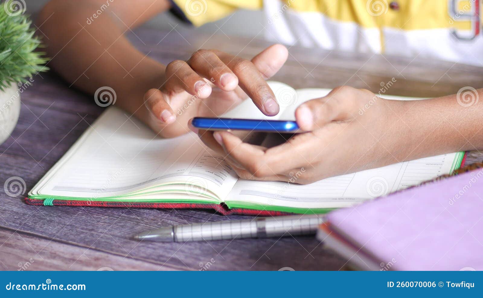 Teenage Boy Using Smart Phone and Notepad on Table Stock Footage ...