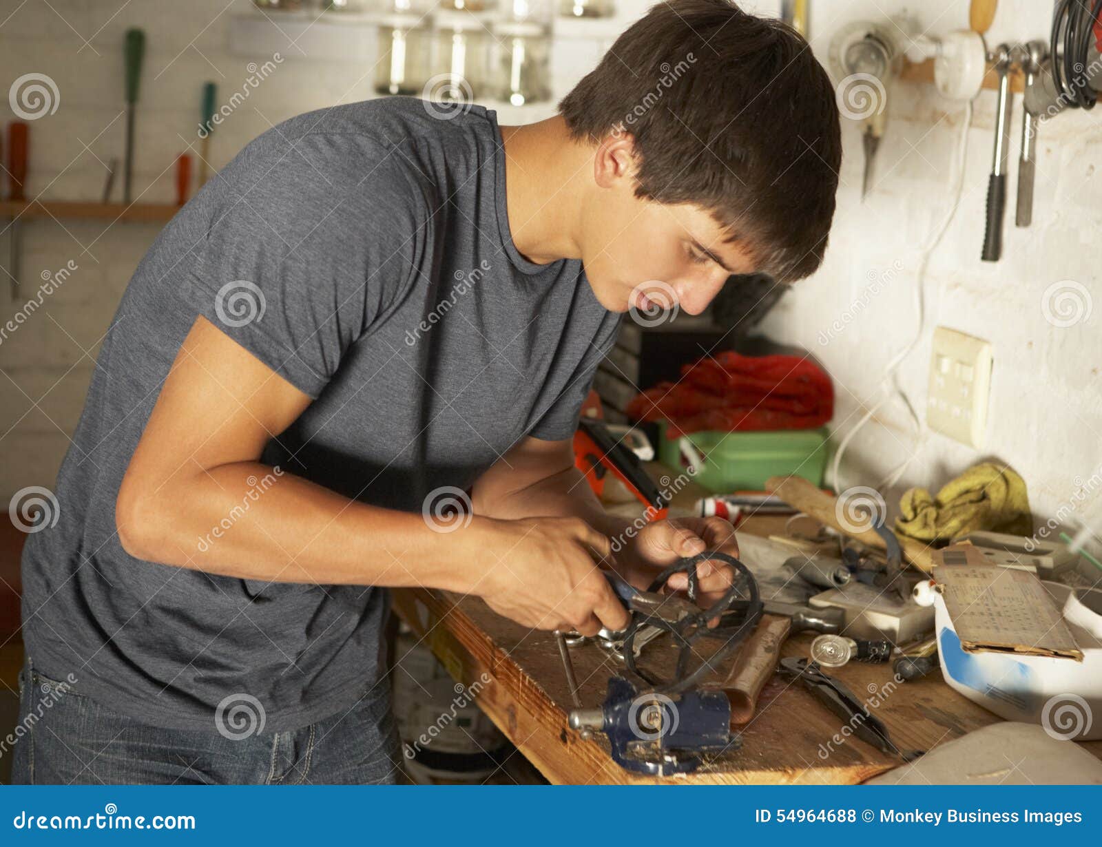 Teenage Boy Using Workbench in Garage Stock Photo - Image of indoors ...