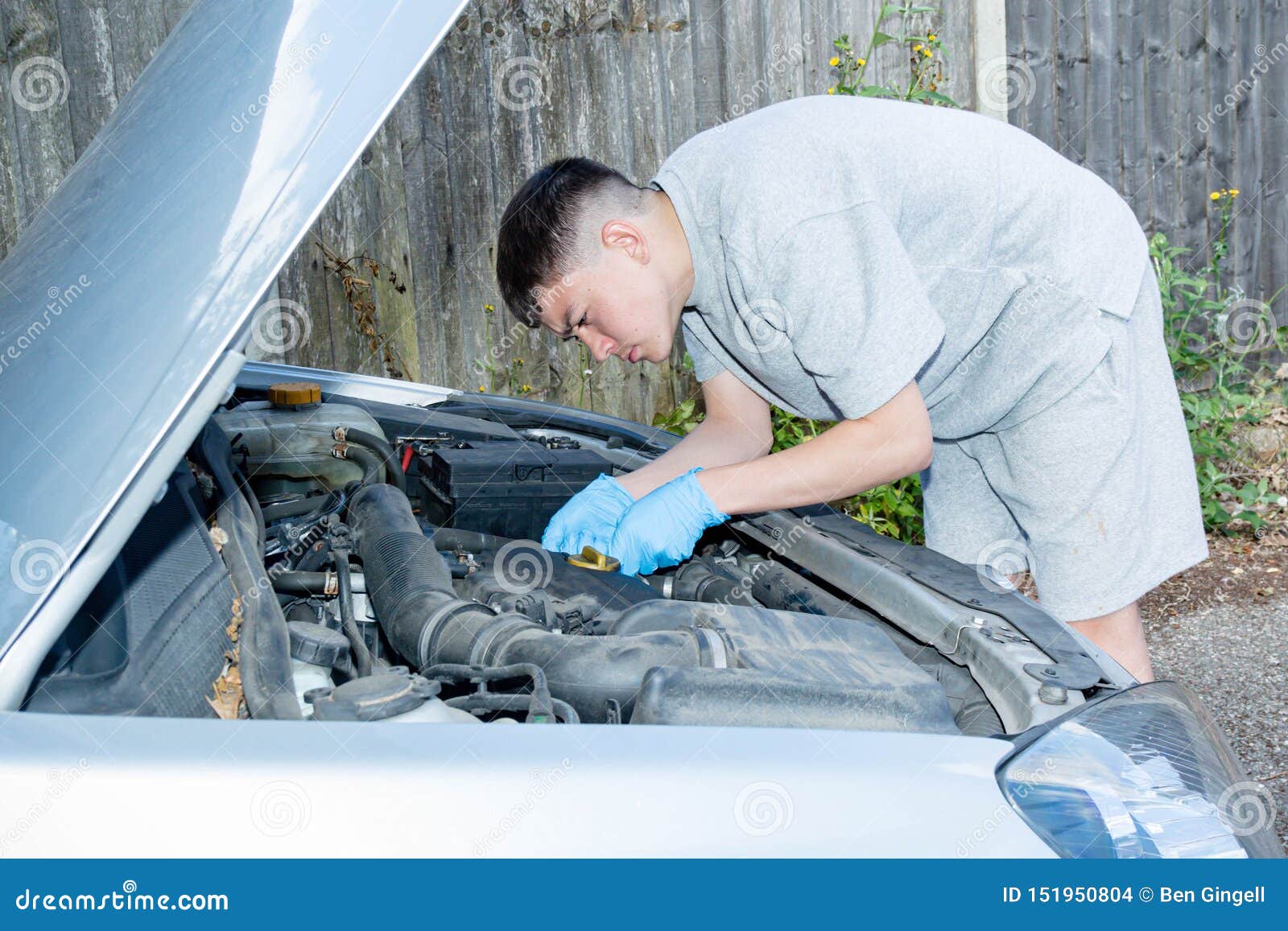 Teenage Boy Working on a Car Stock Photo - Image of bonnet, device ...