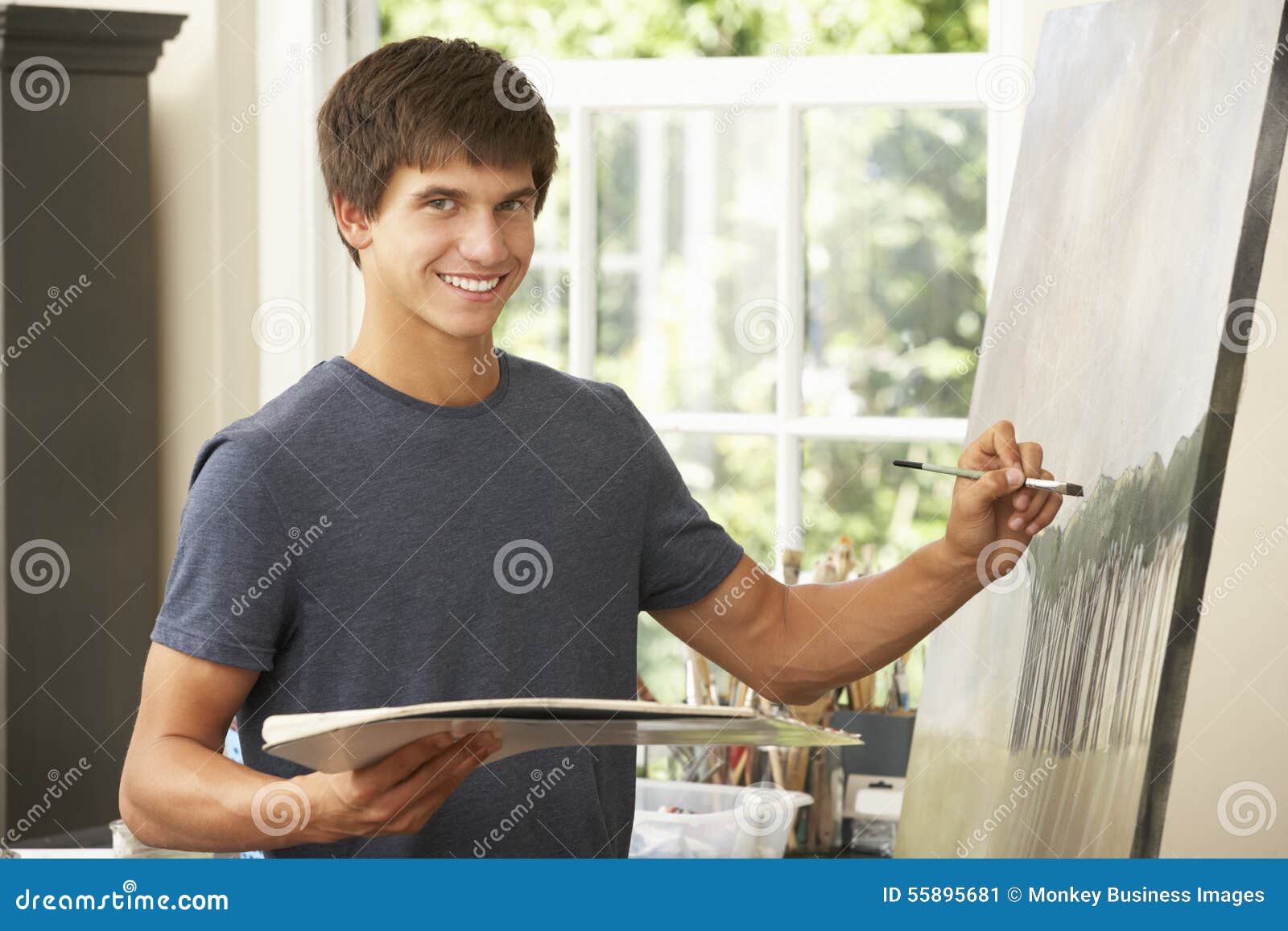 Teenage Boy Working on Painting in Studio Stock Image - Image of ...