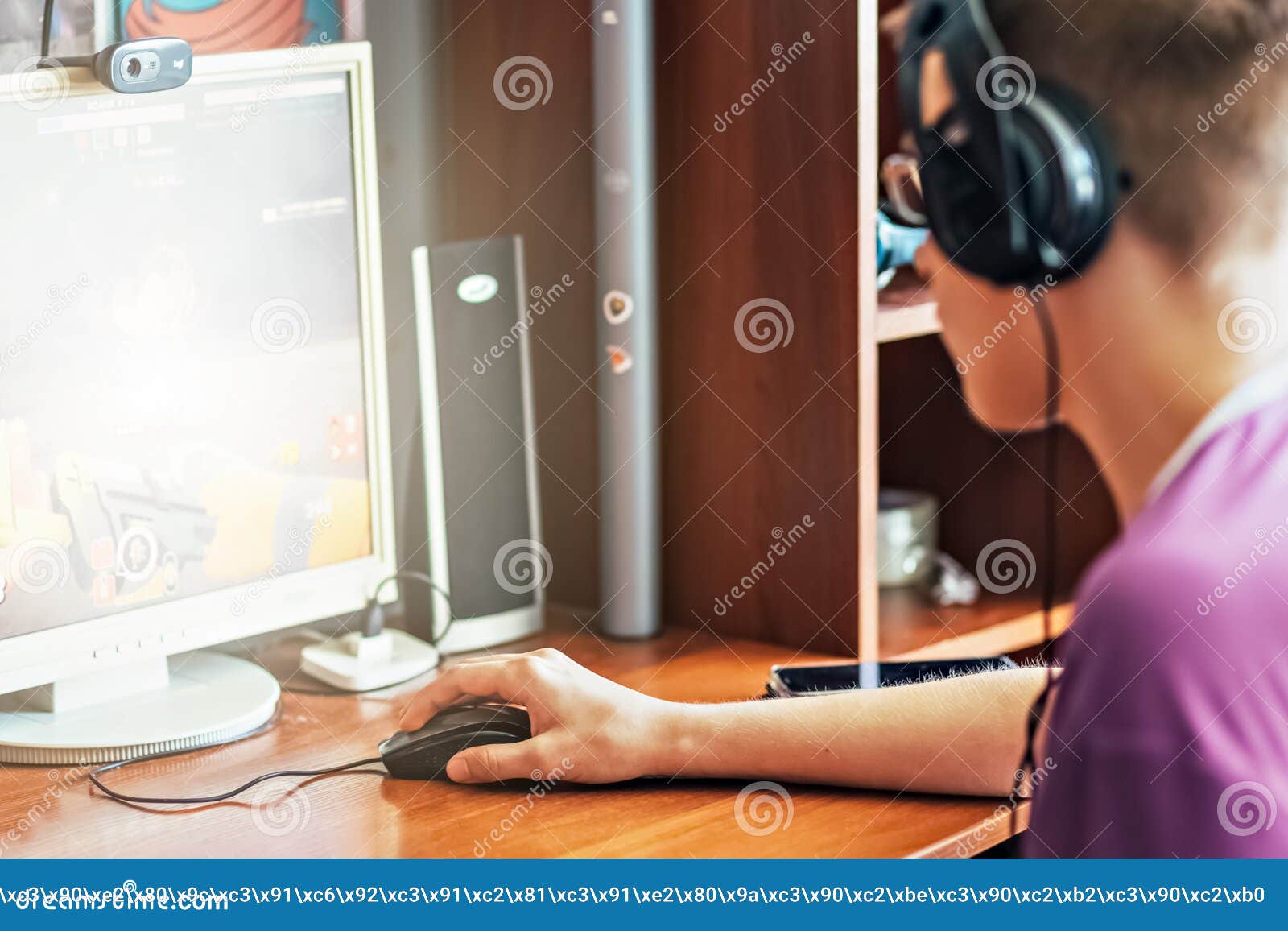 A Teenage Boy, a Young Man Playing Video Games on a Computer, Using ...