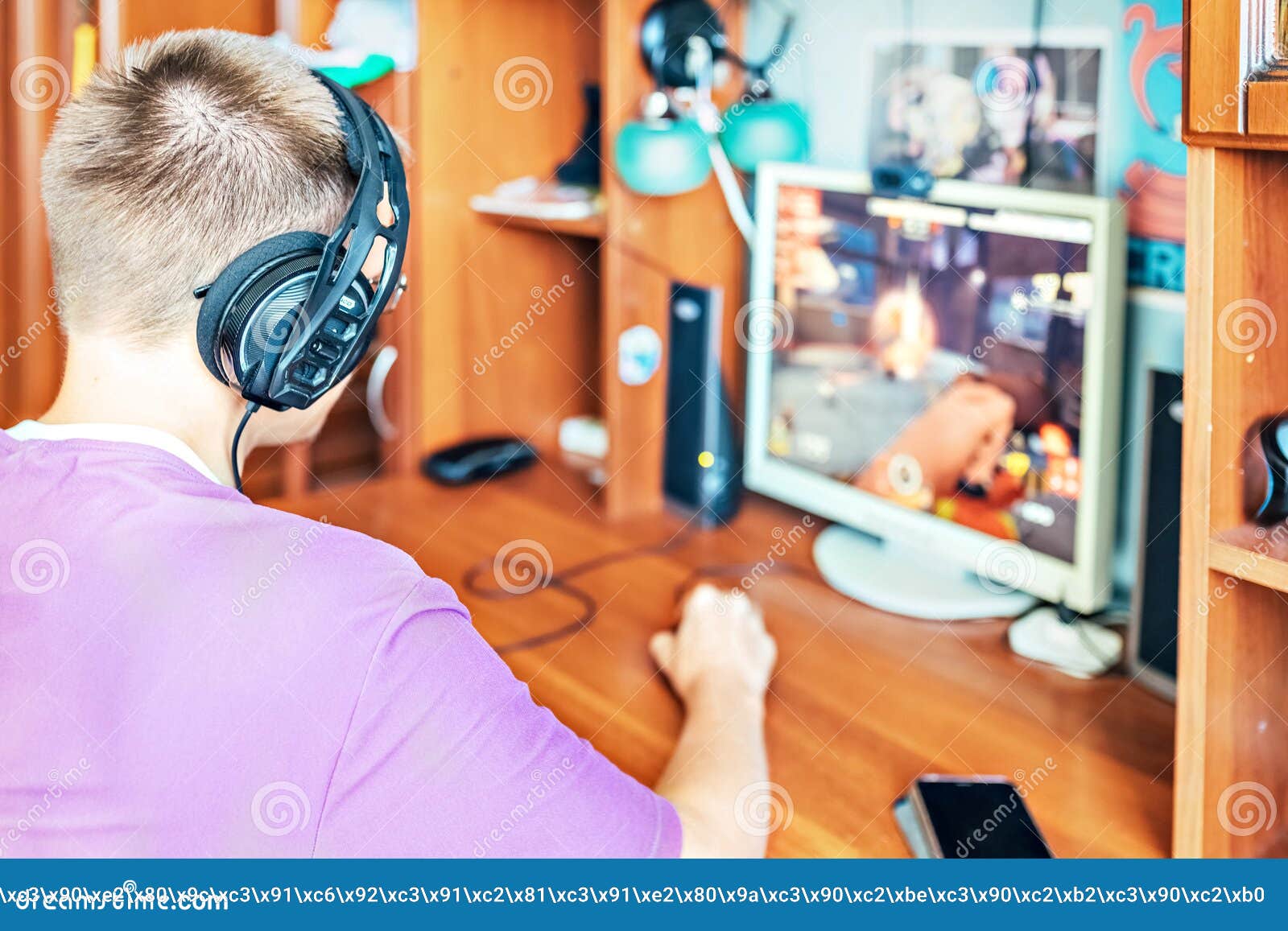 A Teenage Boy, a Young Man Playing Video Games on a Computer, Using ...