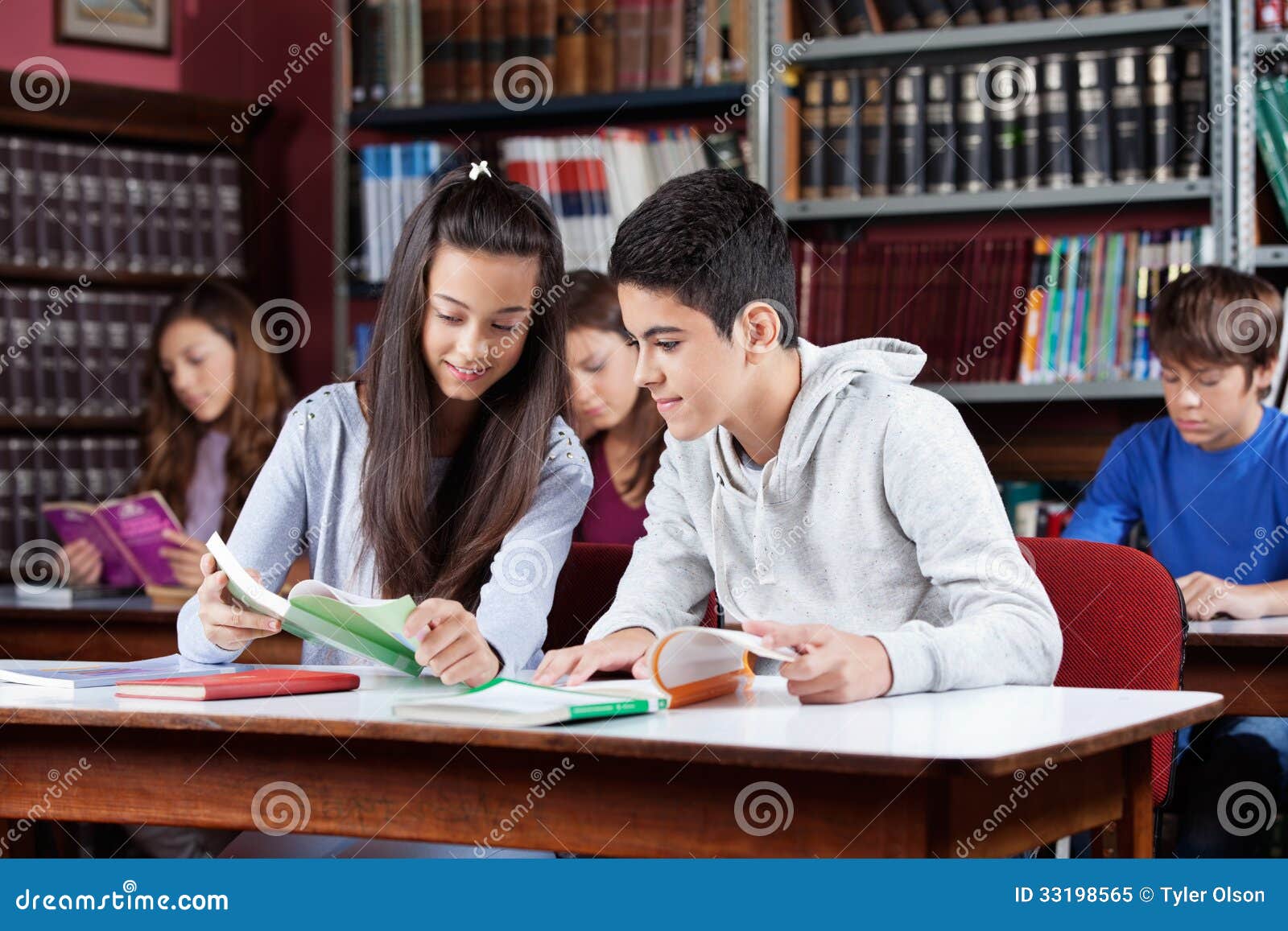 Teenage Classmates Reading Book In Library Stock Image - Image of many ...