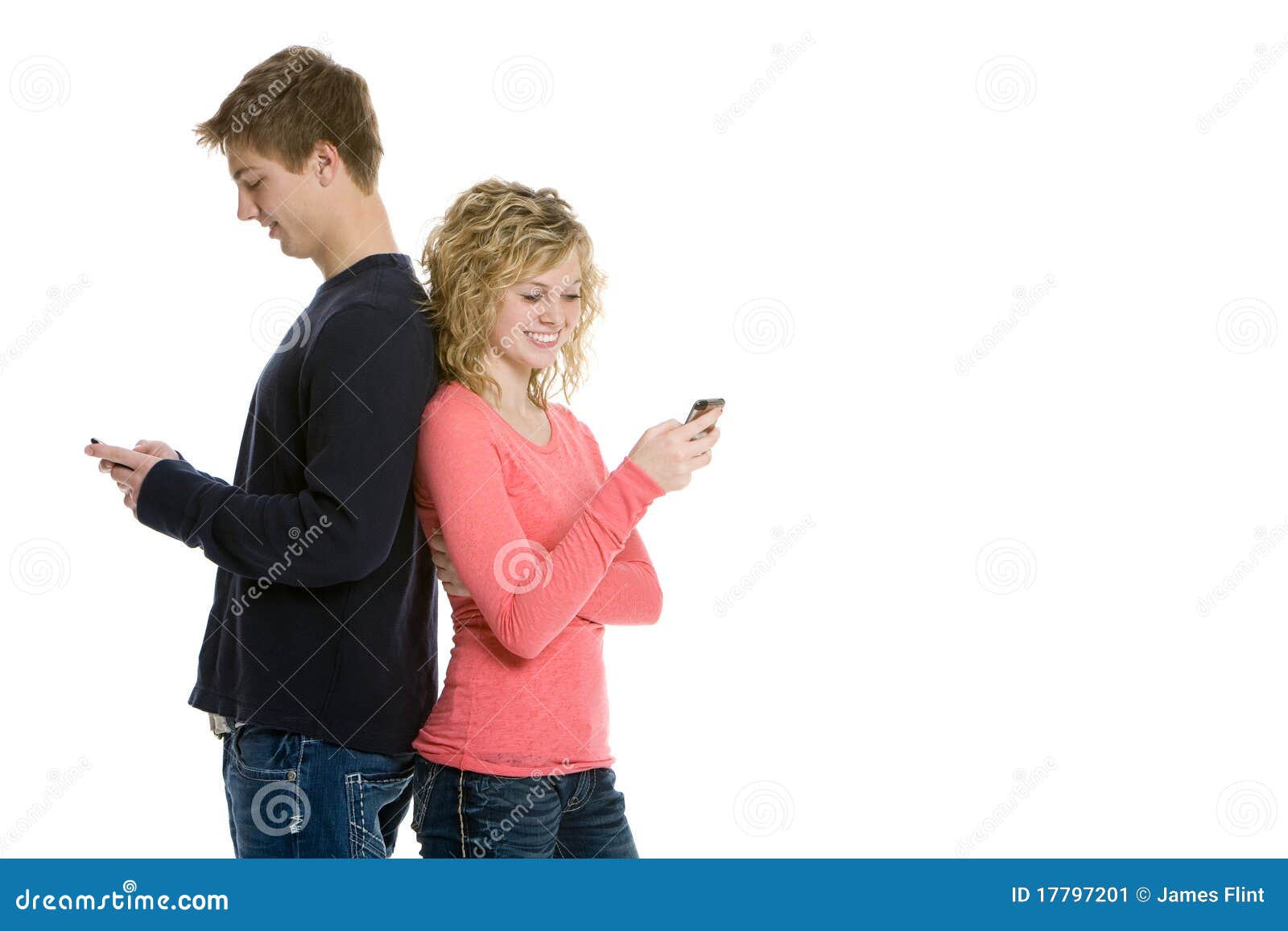 Teenage Couple Standing Using Cell Phones Stock Image - Image of ...