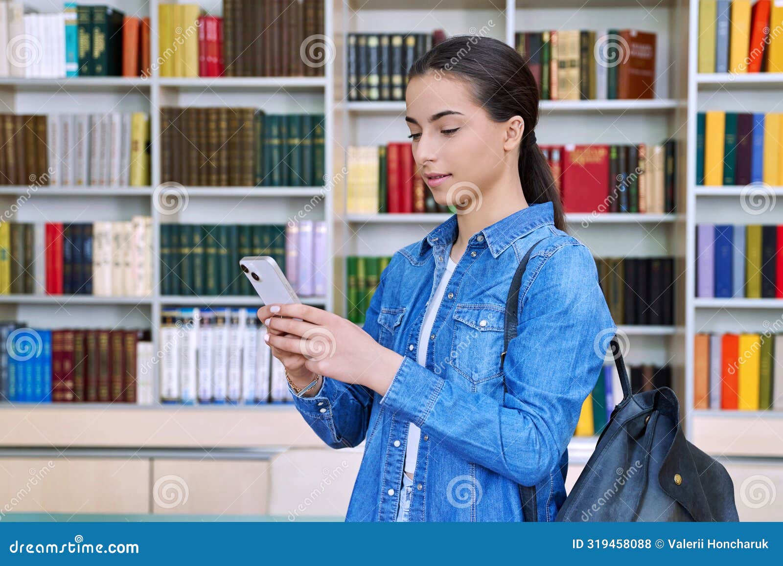Teenage Female Student Using Smartphone, Inside High School Building ...