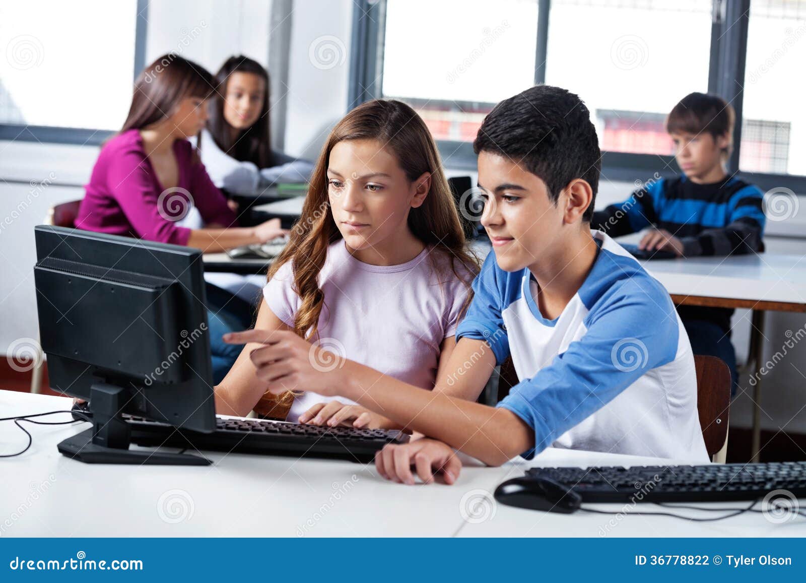 Teenage Friends Using Computer in Lab Stock Photo - Image of pointing ...