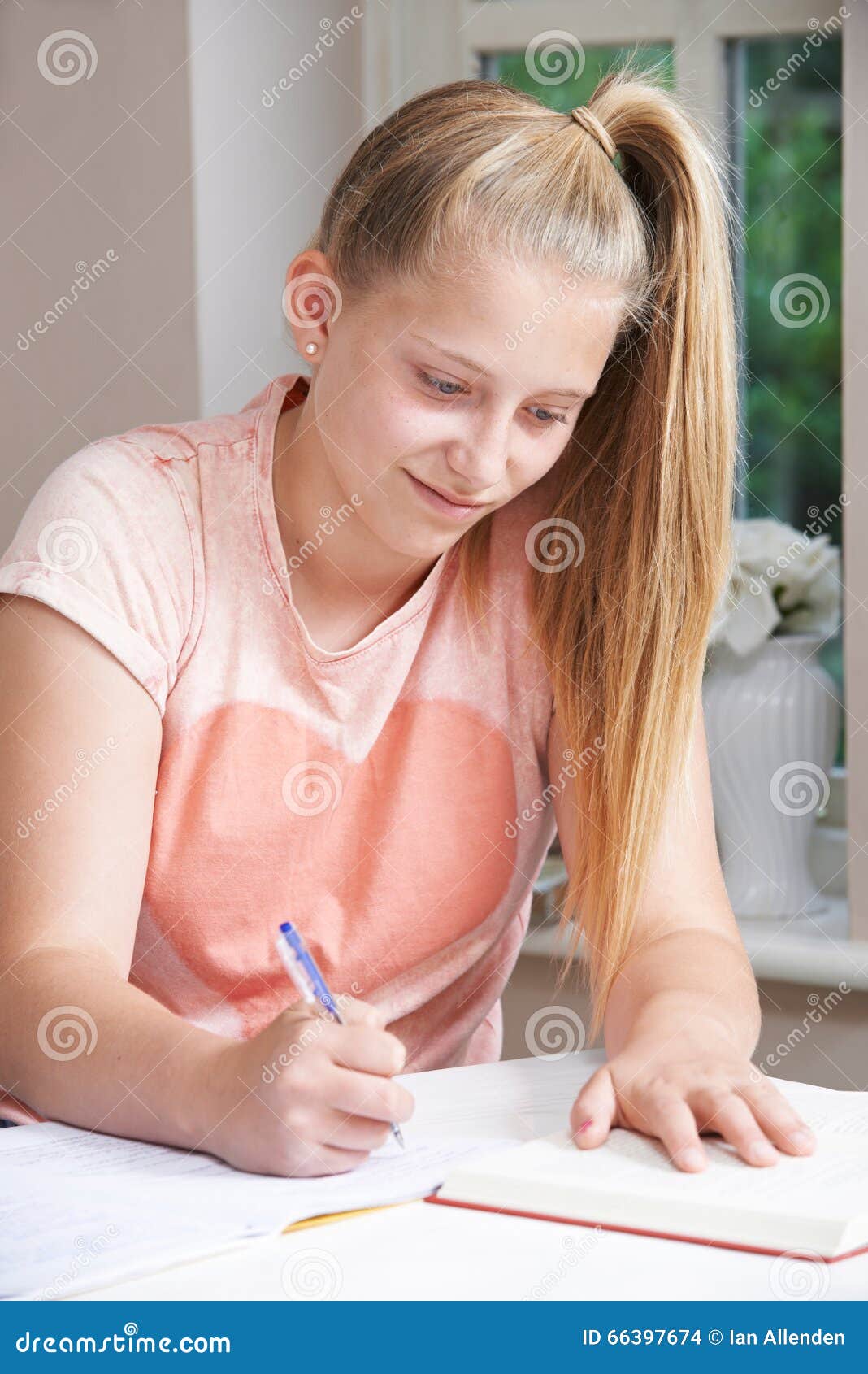 Teenage Girl Doing Homework at Table Stock Photo - Image of writing ...