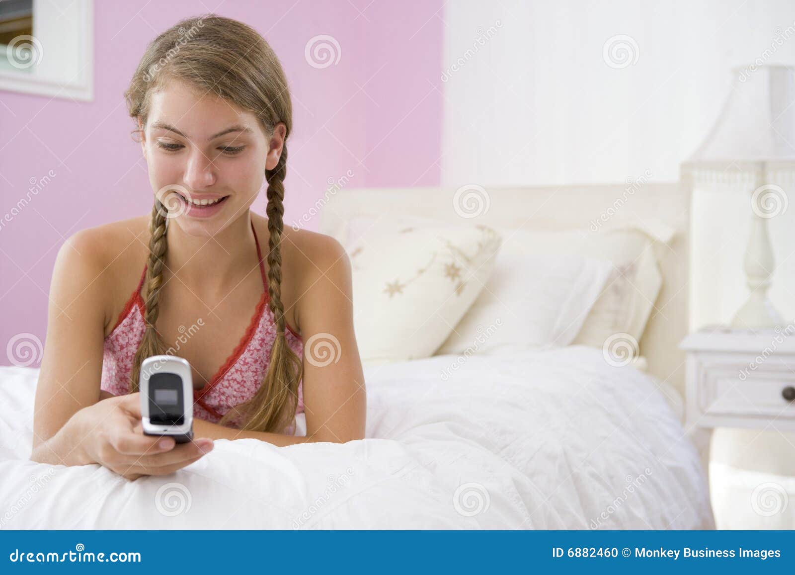 Teenage Girl Lying on Bed Using Mobile Phone Stock Photo - Image of ... Teenage Girl Lying on Bed Using Mobile Phone Stock Photo - Image of ...