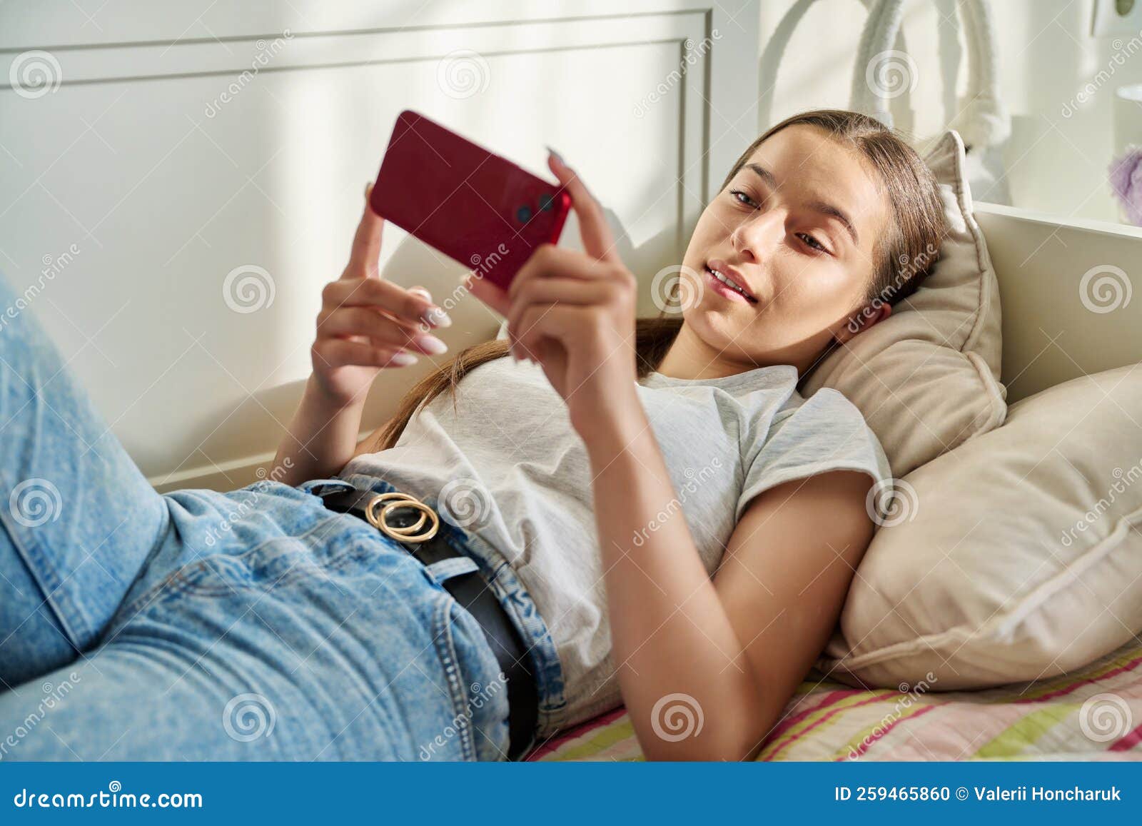 Teenage Girl Lying in Bed Using Smartphone for Leisure Communication ... Teenage Girl Lying in Bed Using Smartphone for Leisure Communication ...