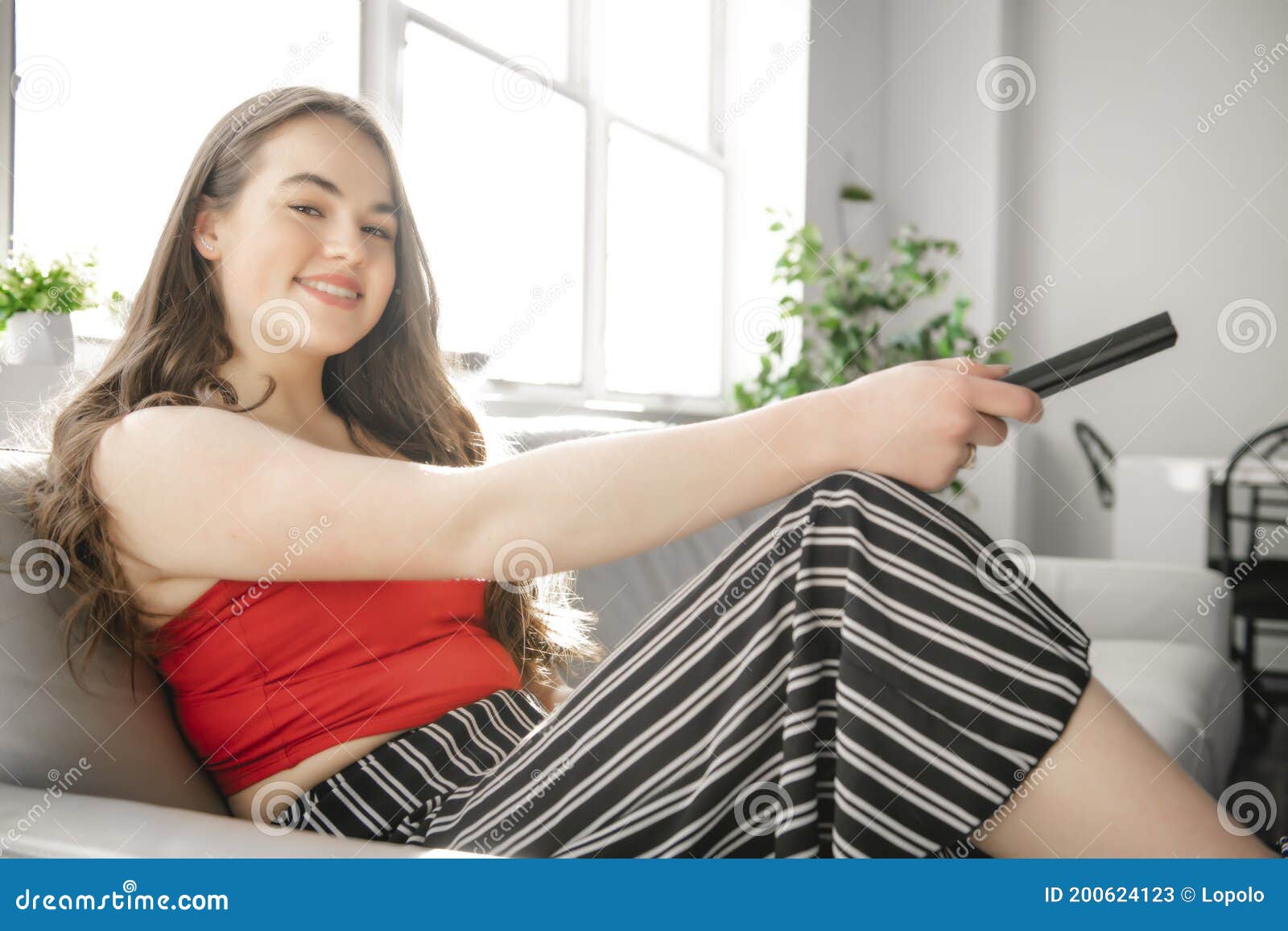 A Teenage Girl Relaxing At Home Watching Television Stock Image Image