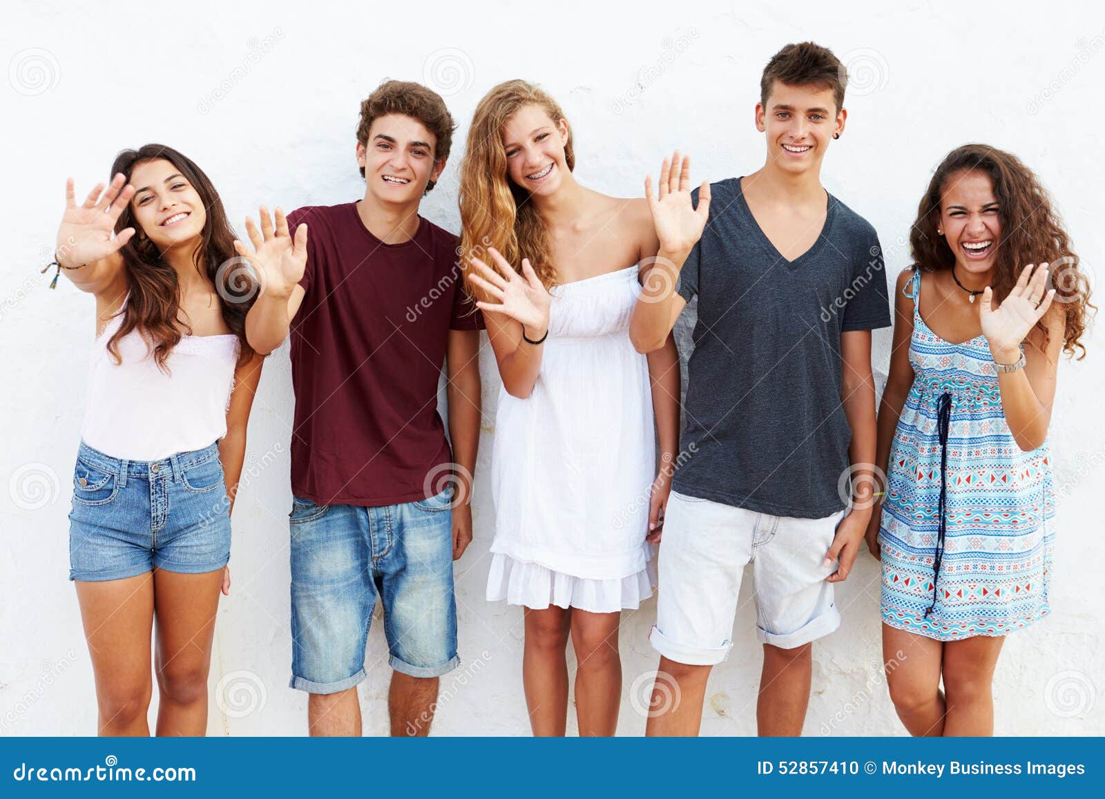 Teenage Group Leaning Against Wall Waving Stock Photo - Image of ...