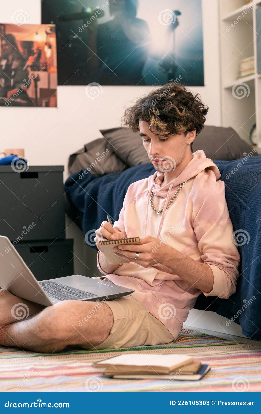 Teenage Guy Making Notes in Notepad while Sitting on the Floor Stock ...