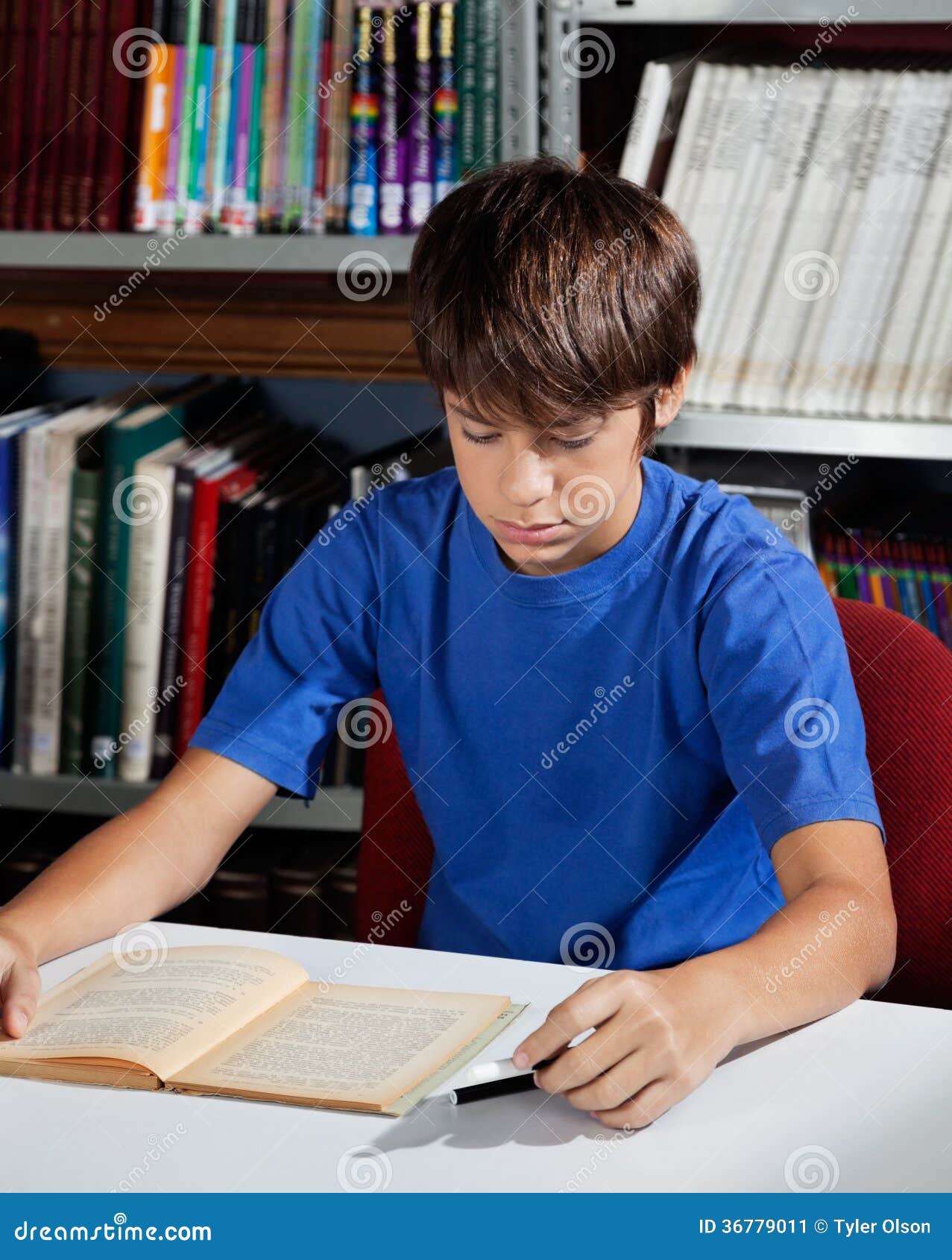 Teenage Schoolboy Reading Book in Library Stock Image - Image of ...