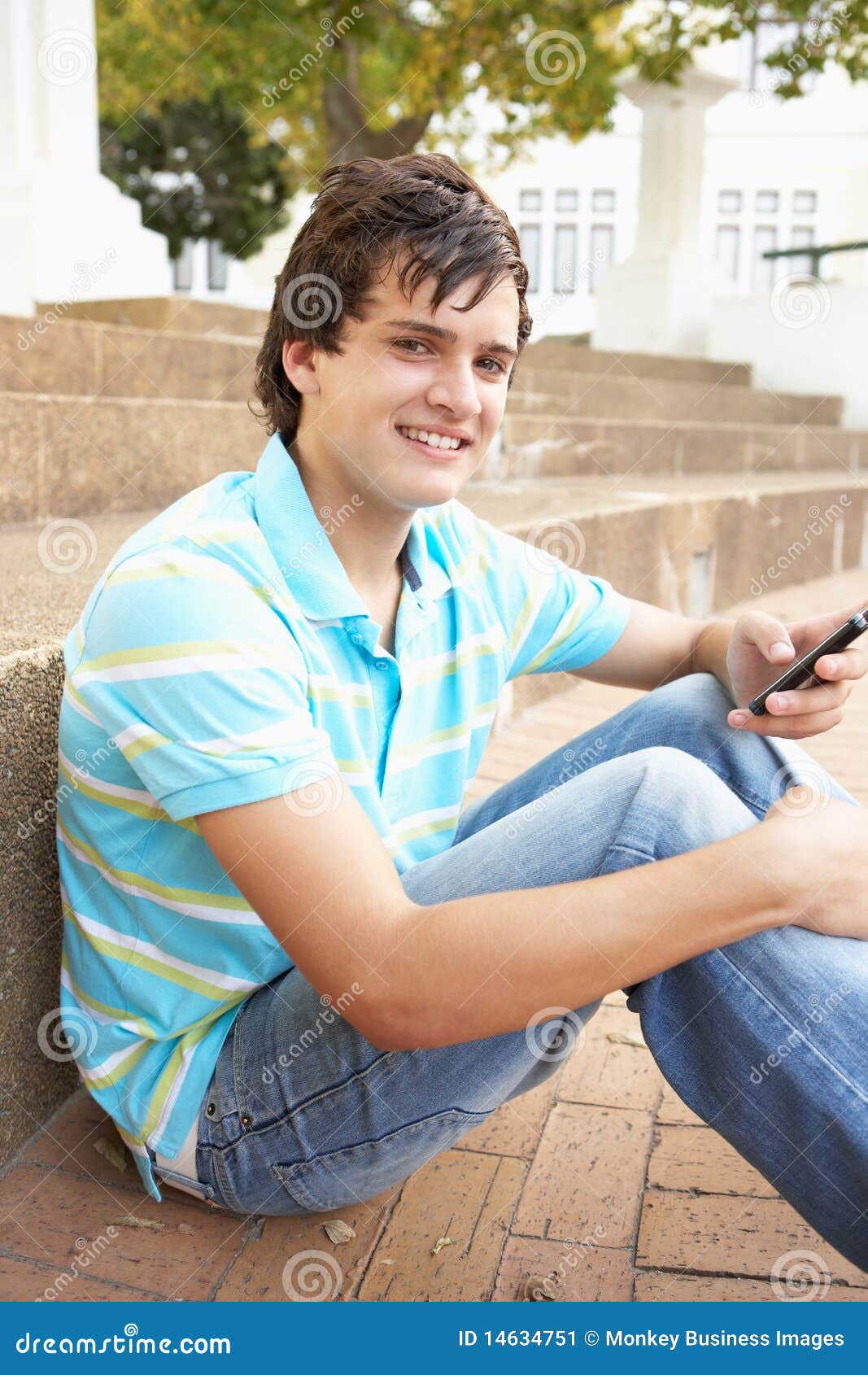 Teenage Student Sitting Outside Using Mobile Phone Stock Image - Image ...
