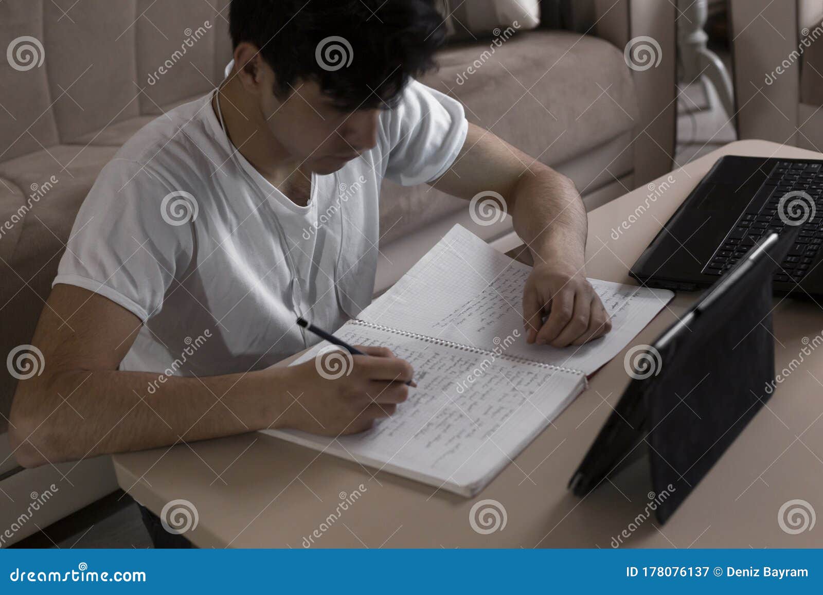 Teenage Student Studying at Home Using His Tablet and Computer Stock ...