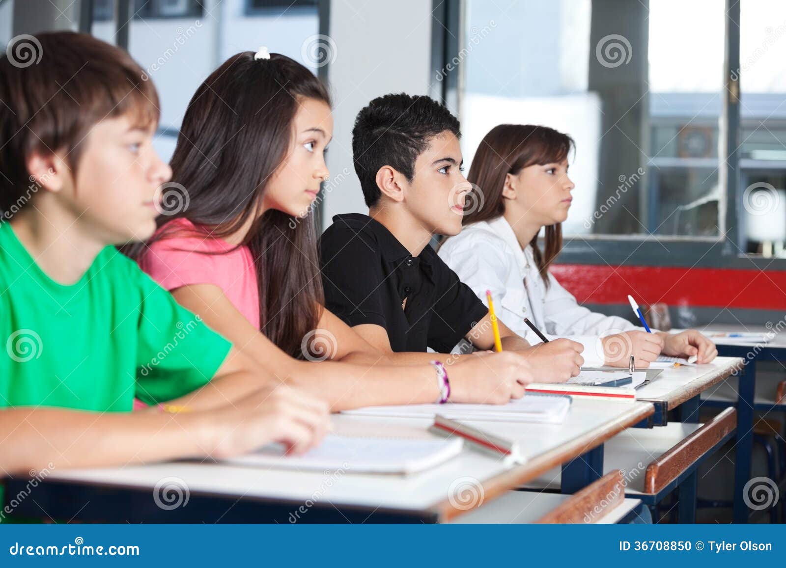Teenage Students Looking Away while Studying at Stock Photo - Image of ...