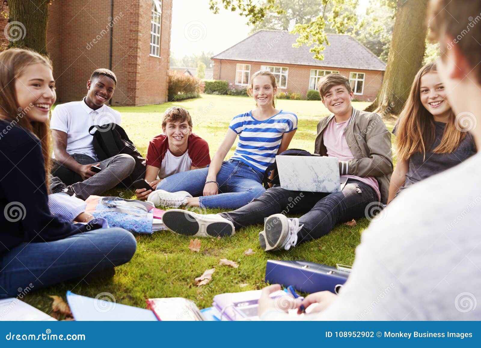 Teenage Students Sitting Outdoors and Working on Project Stock Photo ...