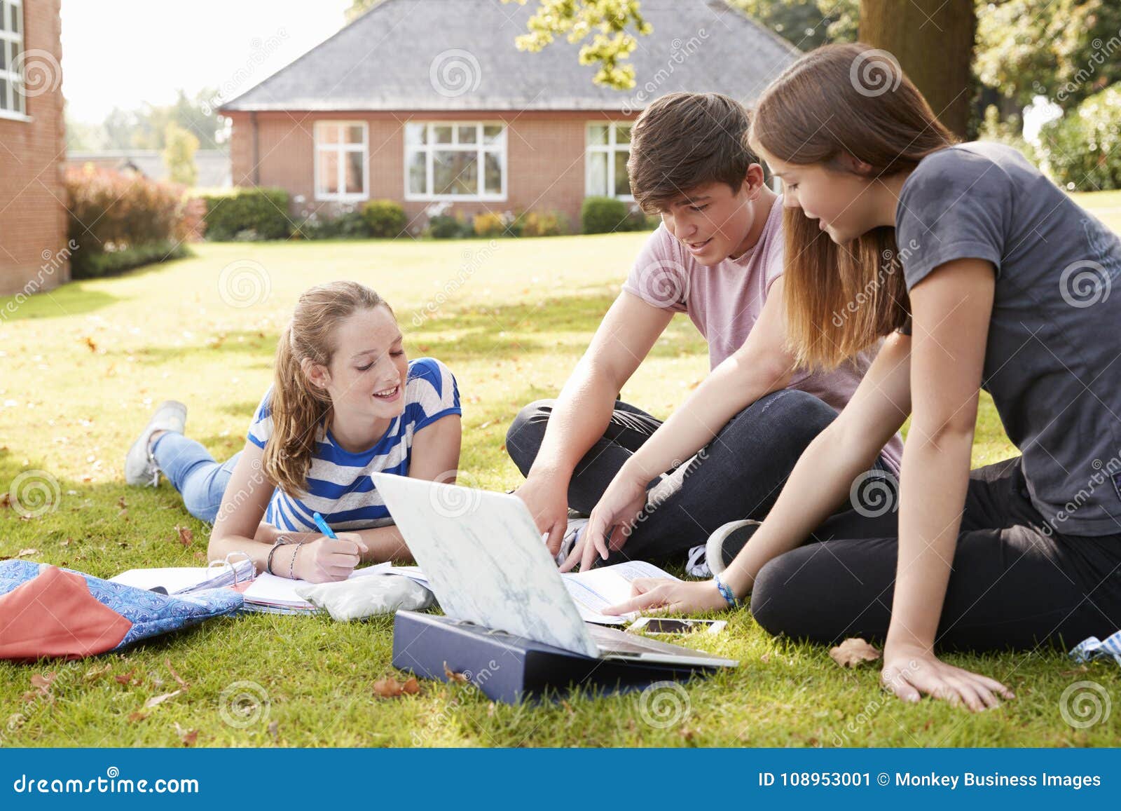 Teenage Students Sitting Outdoors and Working on Project Stock Image ...
