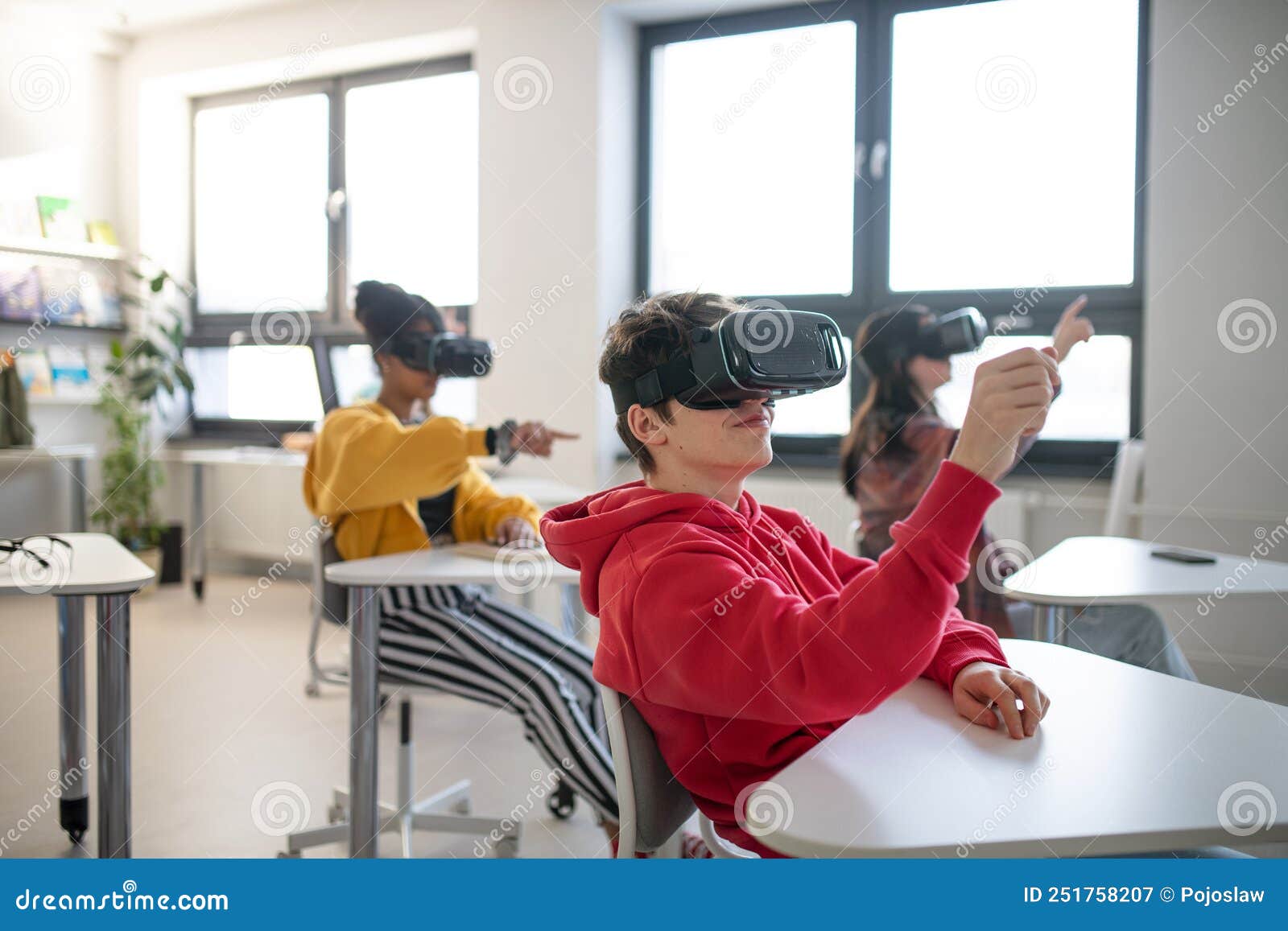 Teenage Students Wearing Virtual Reality Goggles at School in Computer ...