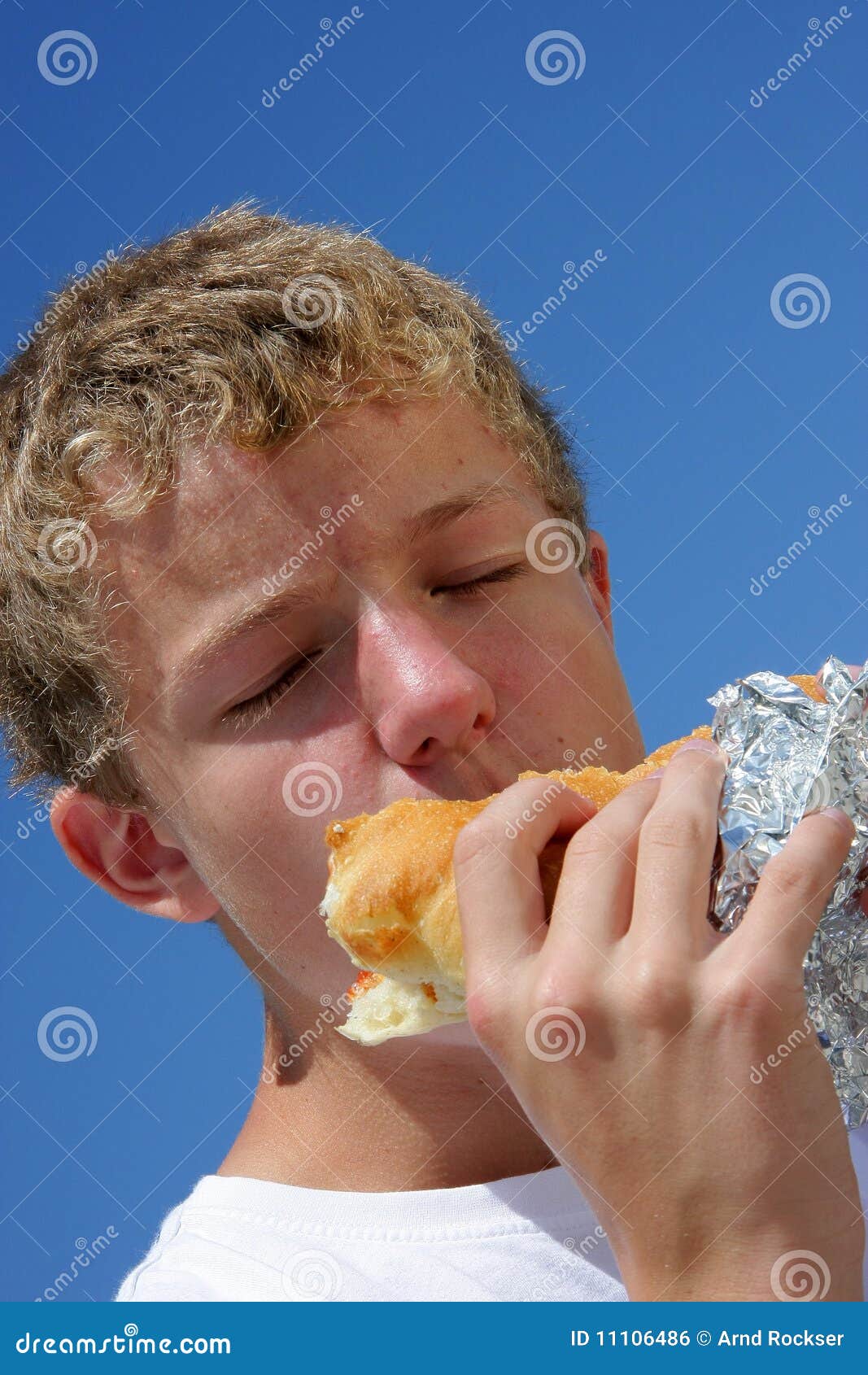 A Teenager Biting into a Sandwich with Closed Eyes Stock Photo - Image ... A Teenager Biting into a Sandwich with Closed Eyes Stock Photo - Image ...