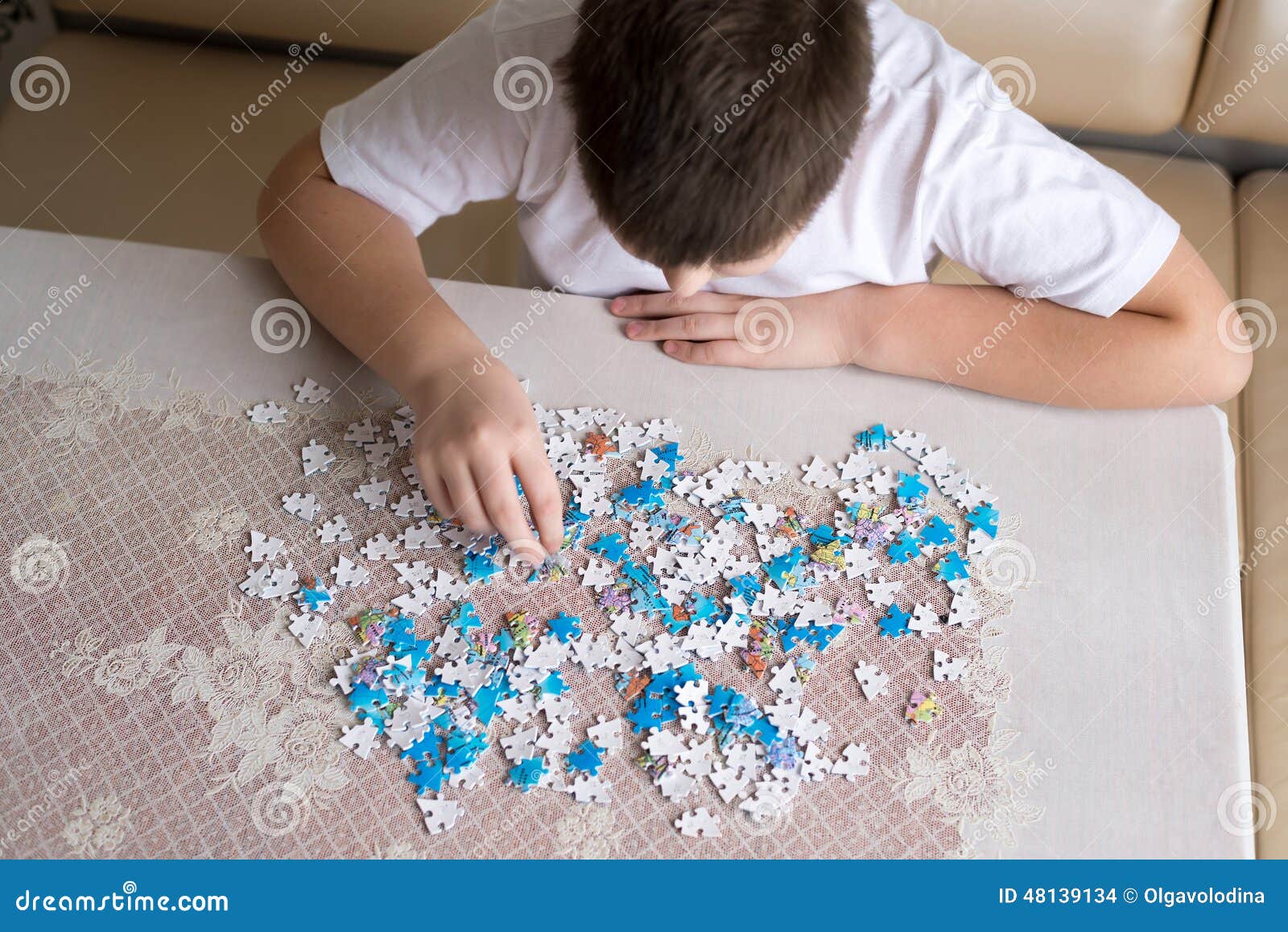 Teenager Boy Collects Puzzles at Table Stock Photo - Image of ...