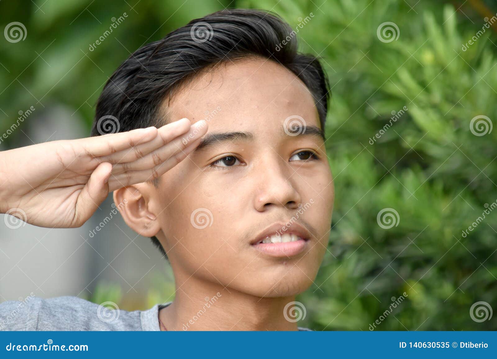 A Teenager Boy Saluting stock image. Image of youth - 140630535