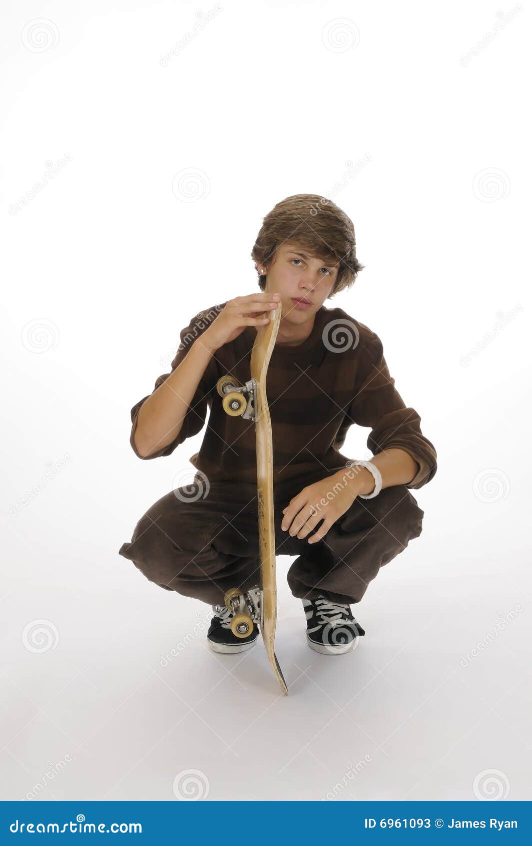 Teenager Crouching Down with Skateboard Stock Image - Image of person ...