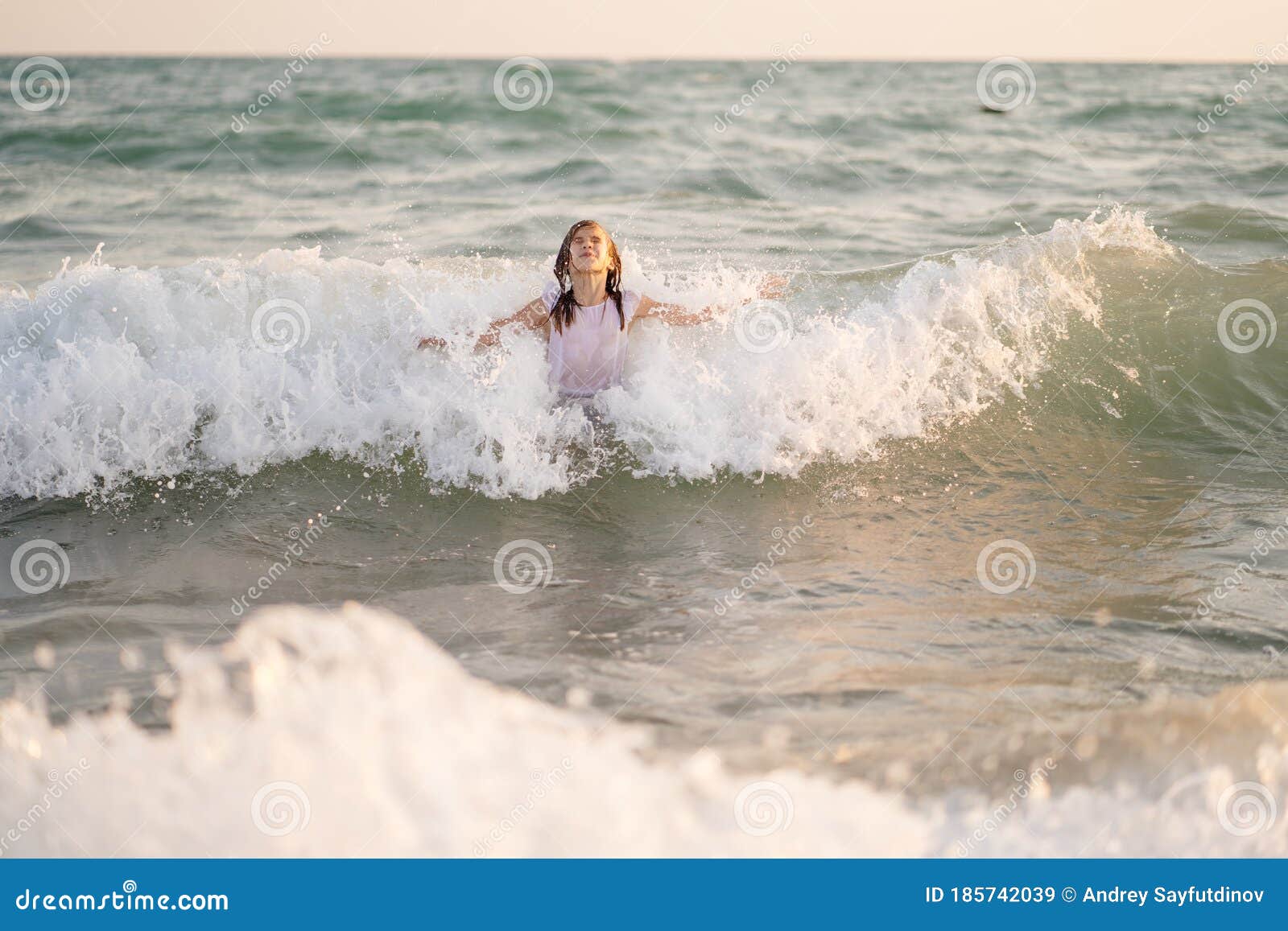 Teenager Girl In Dress Swims In Sea With High Waves Entertainment In