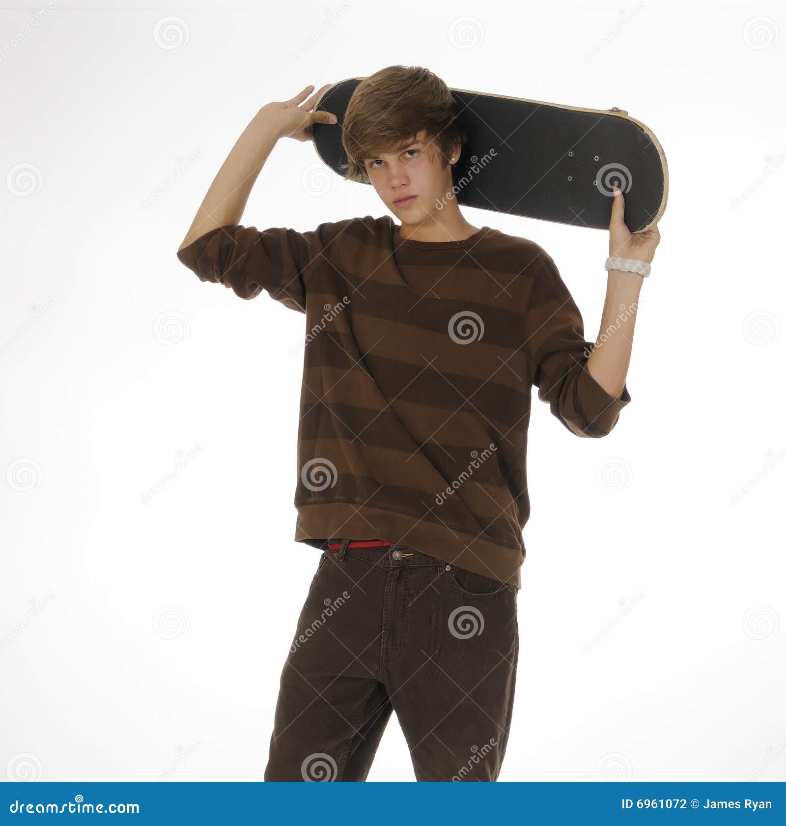 Teenager Holding Skateboard Behind His Head Stock Photo - Image of ... Teenager Holding Skateboard Behind His Head Stock Photo - Image of ...